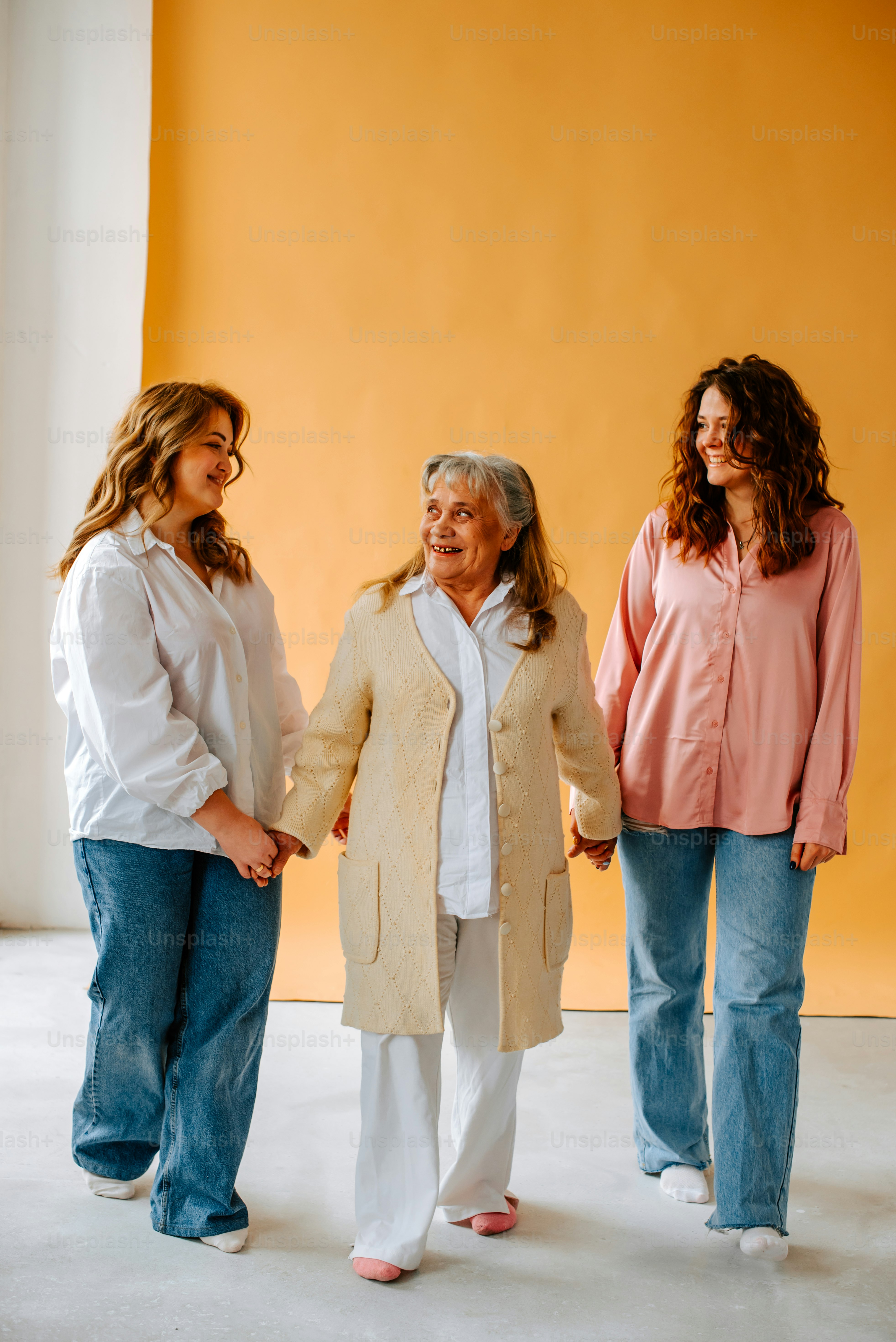 A group of three women standing next to each other photo – Female Image ...