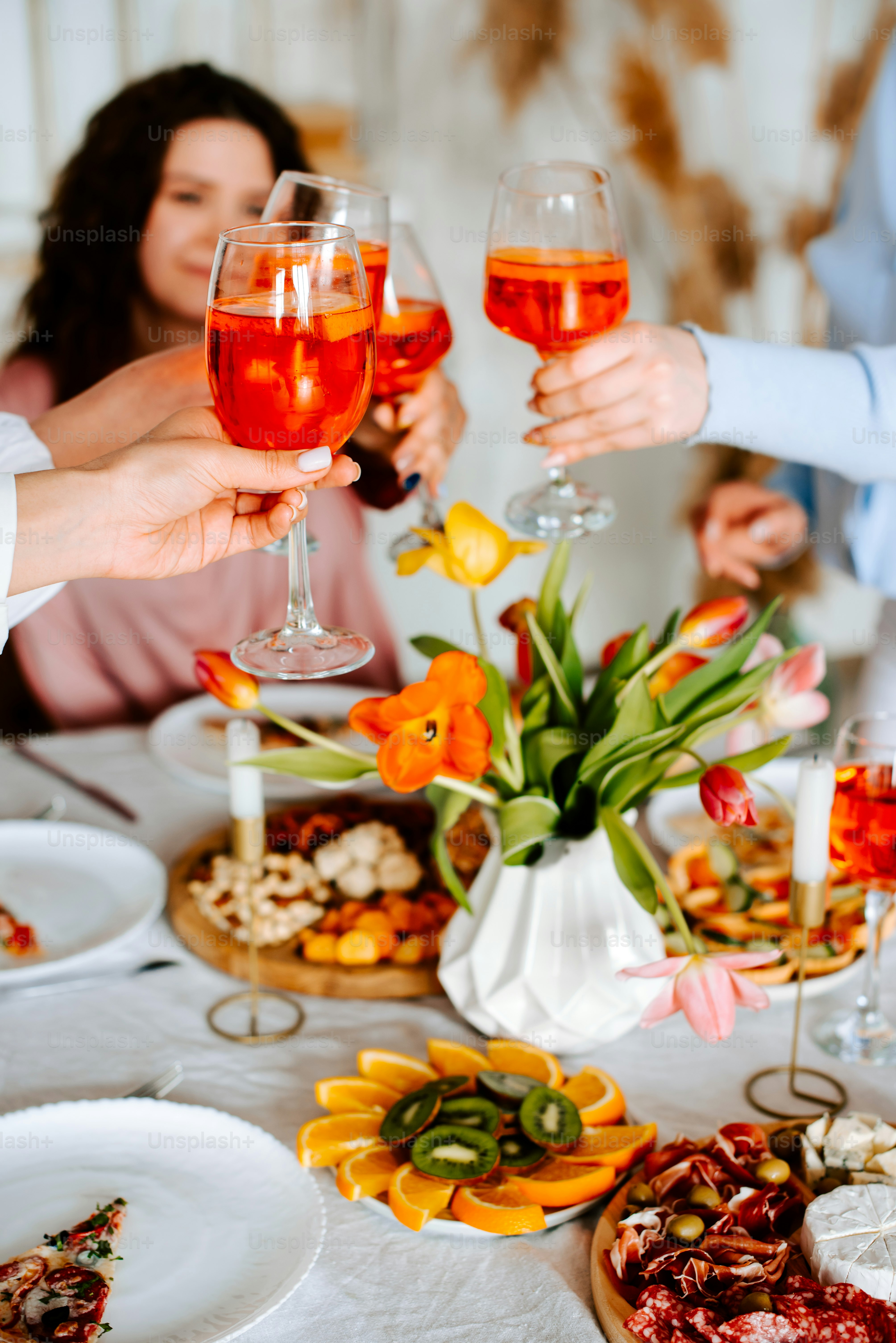 A group of people toasting with wine glasses photo – Food Image on Unsplash