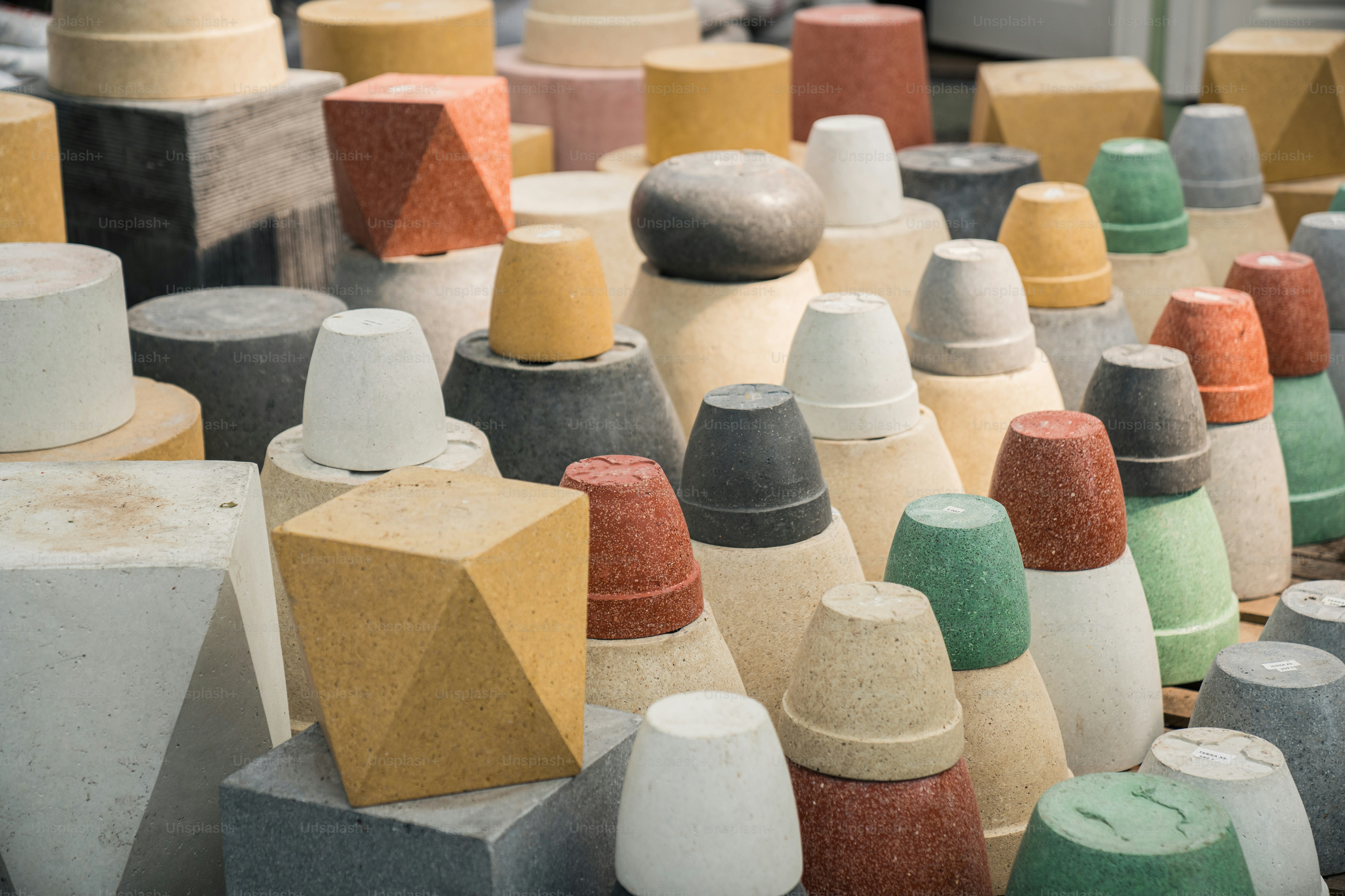 A group of different colored vases sitting on top of each other photo ...