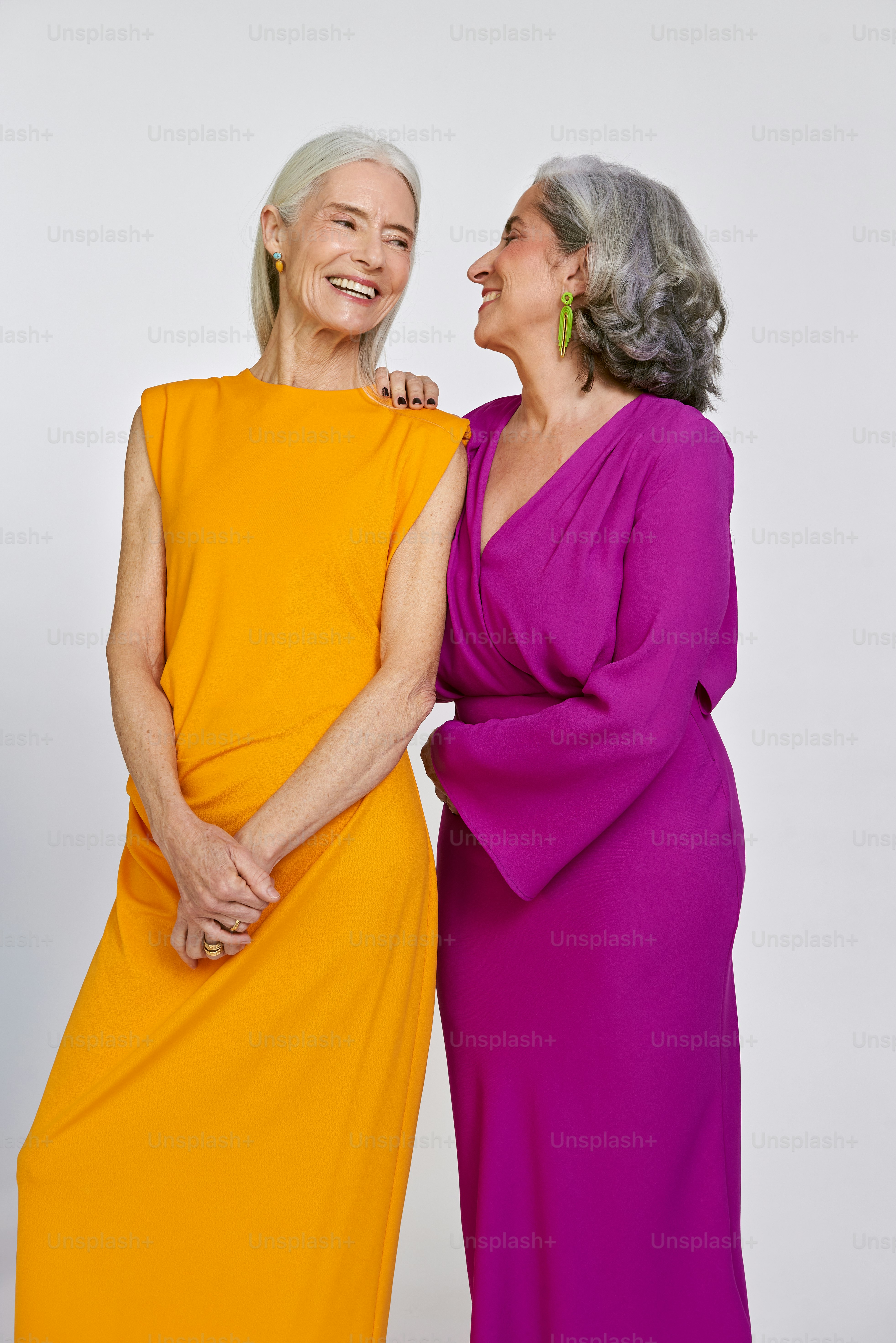 A couple of women standing next to each other photo – Seniors Image on ...