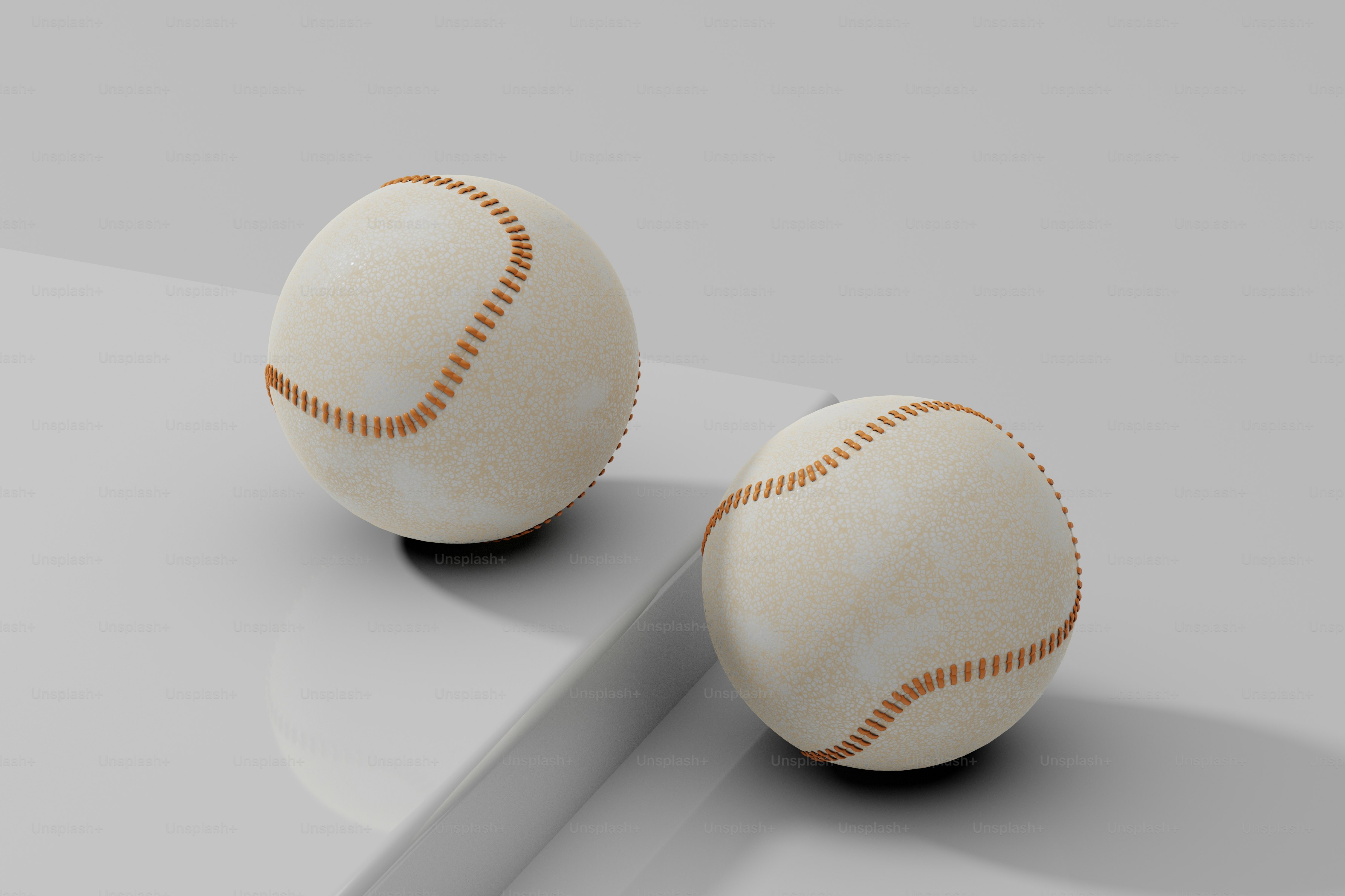 Two baseballs sitting on top of a white surface photo – Baseball Image ...