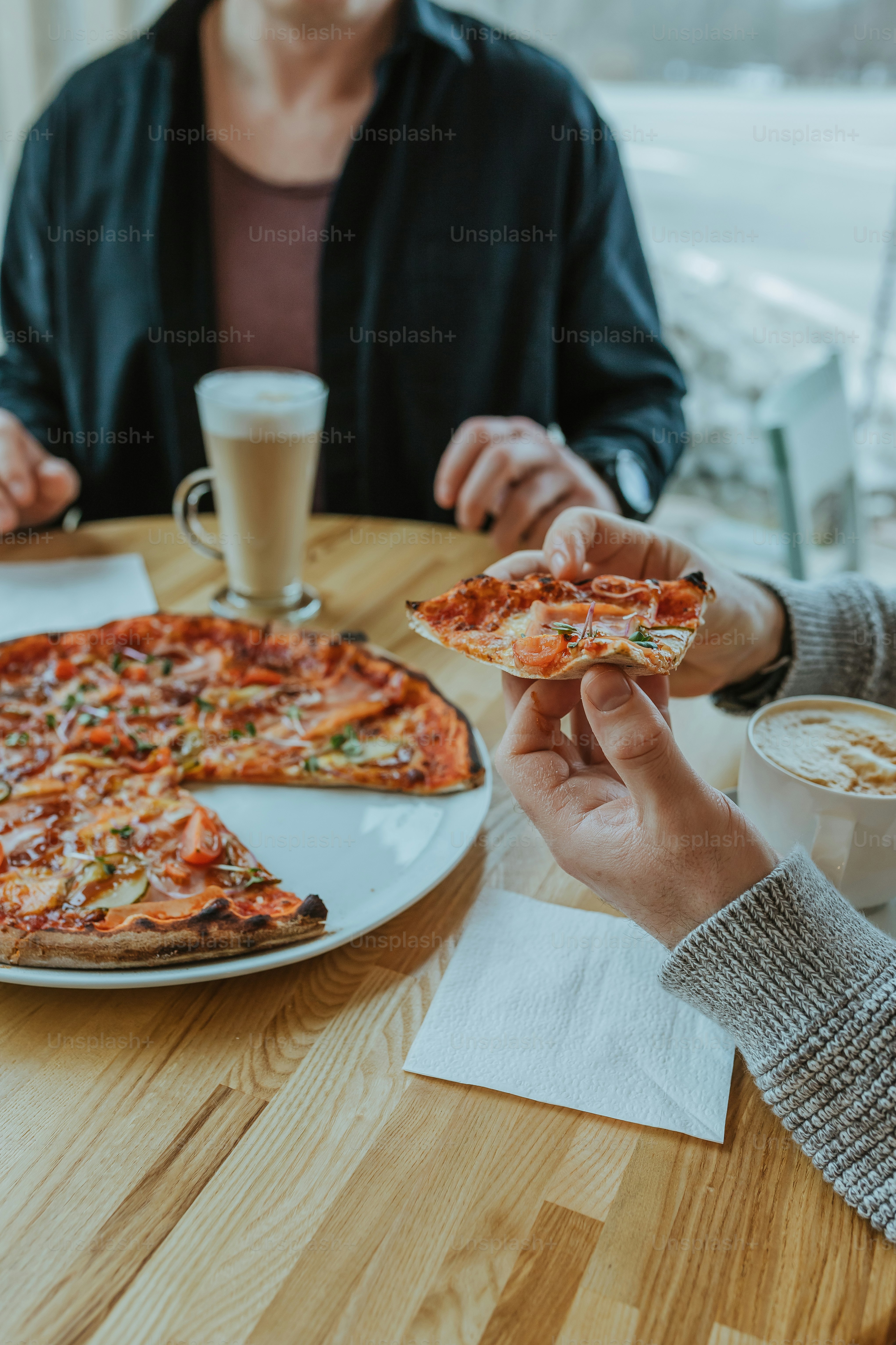 Two People Eating Pizza