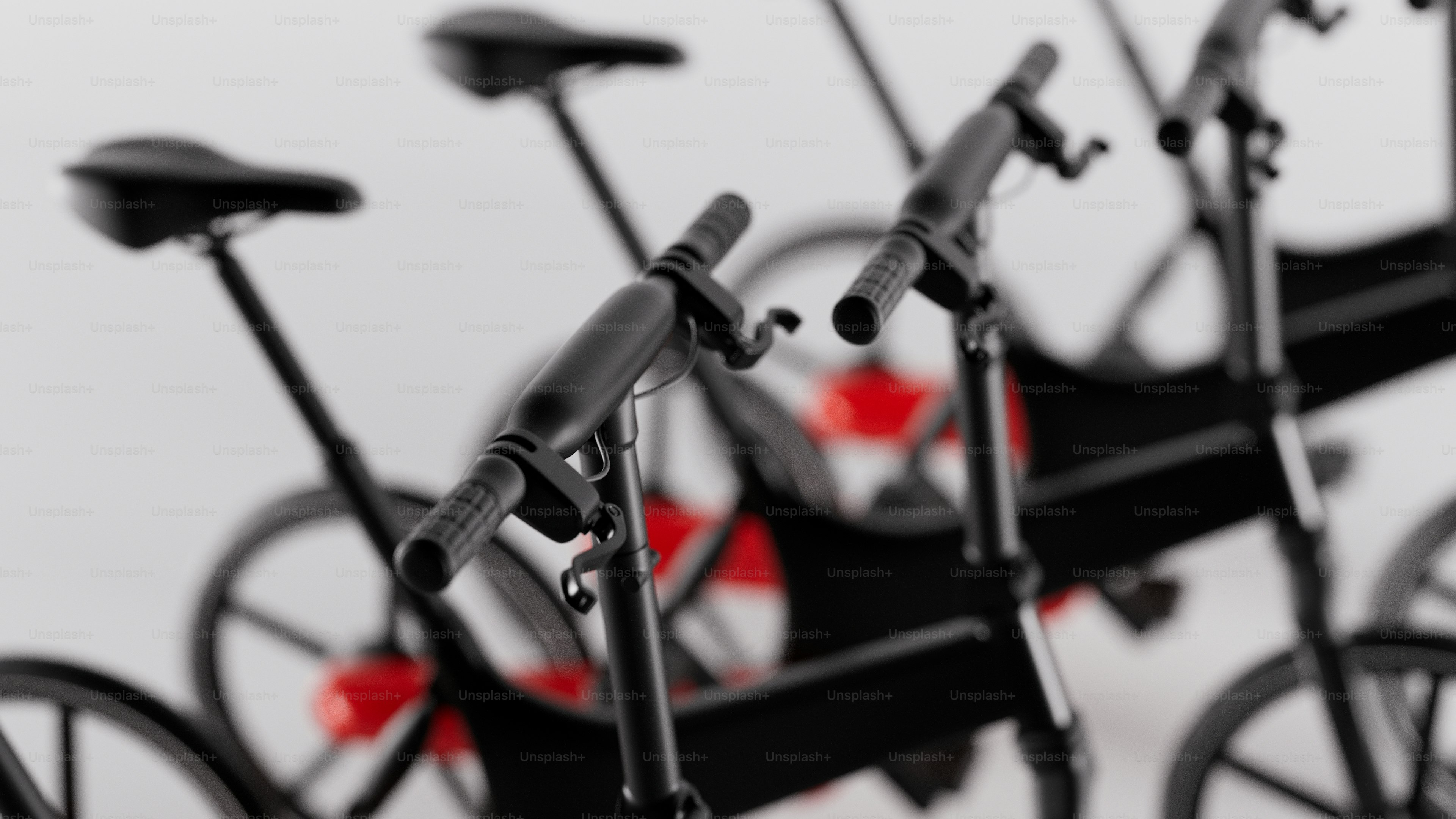 A row of black and red bikes on a white background photo – Bicycle ...