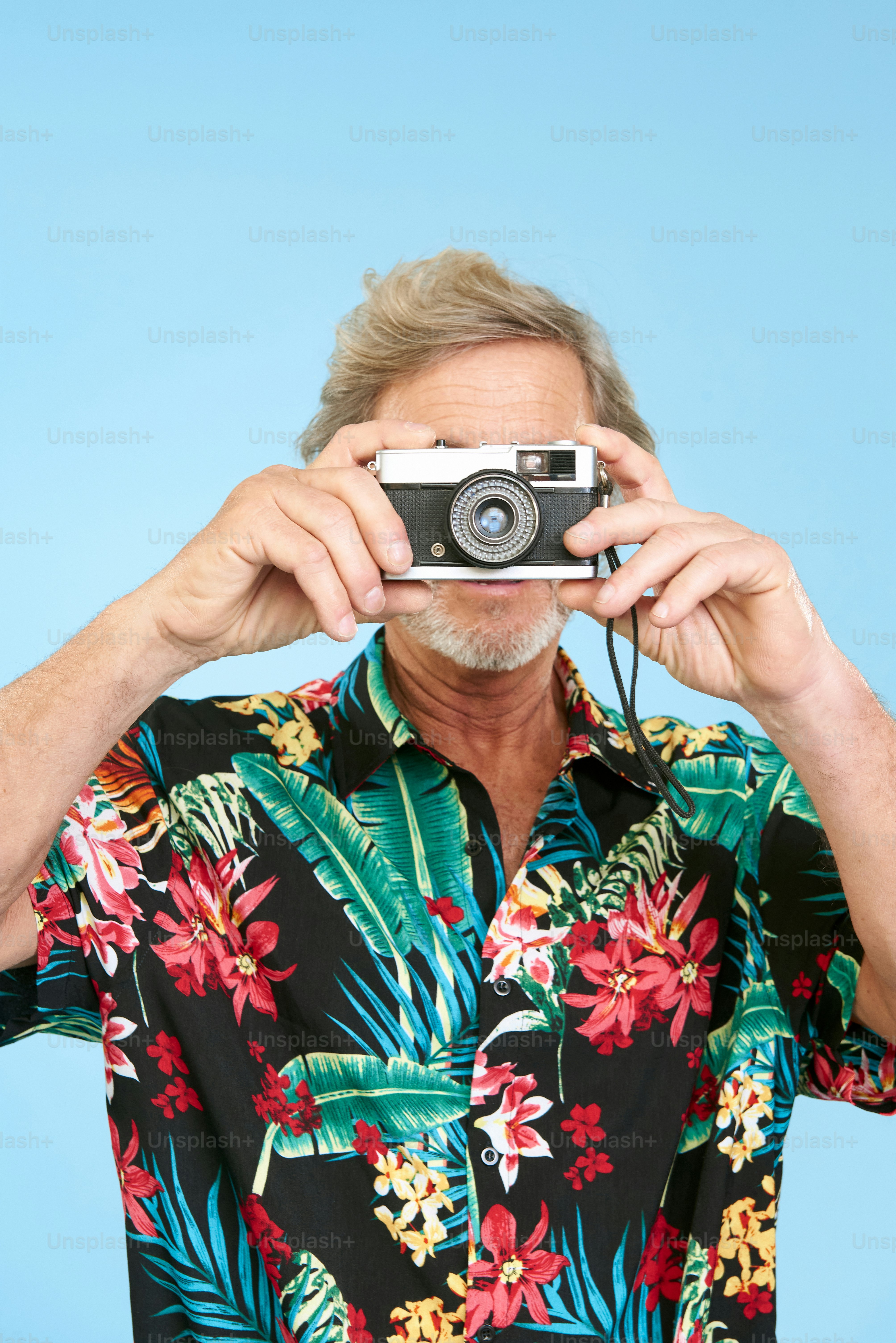 A man holding a camera up to his face photo – Male Image on Unsplash
