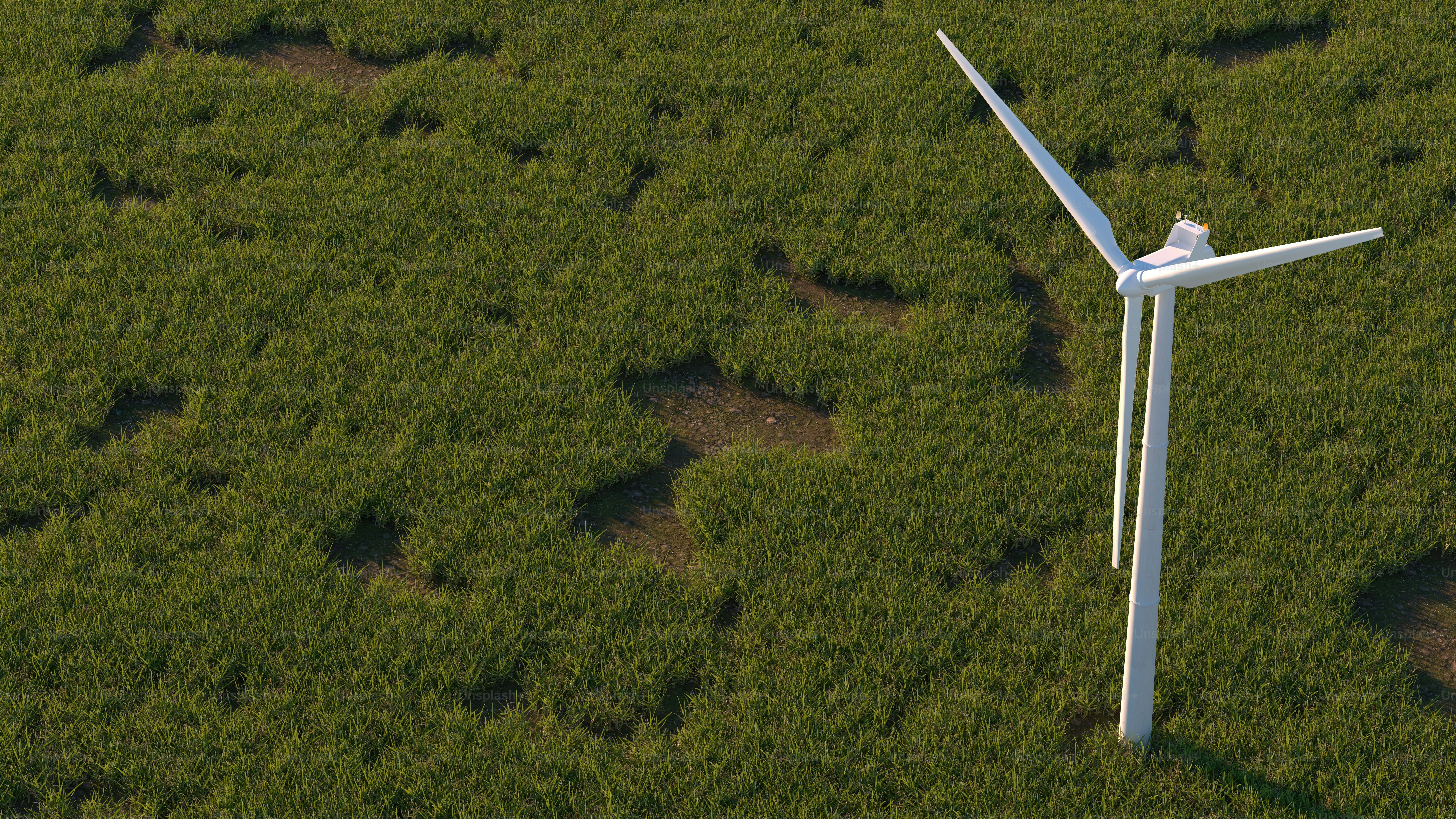 An aerial view of a wind turbine in a green field photo – Wind turbine ...
