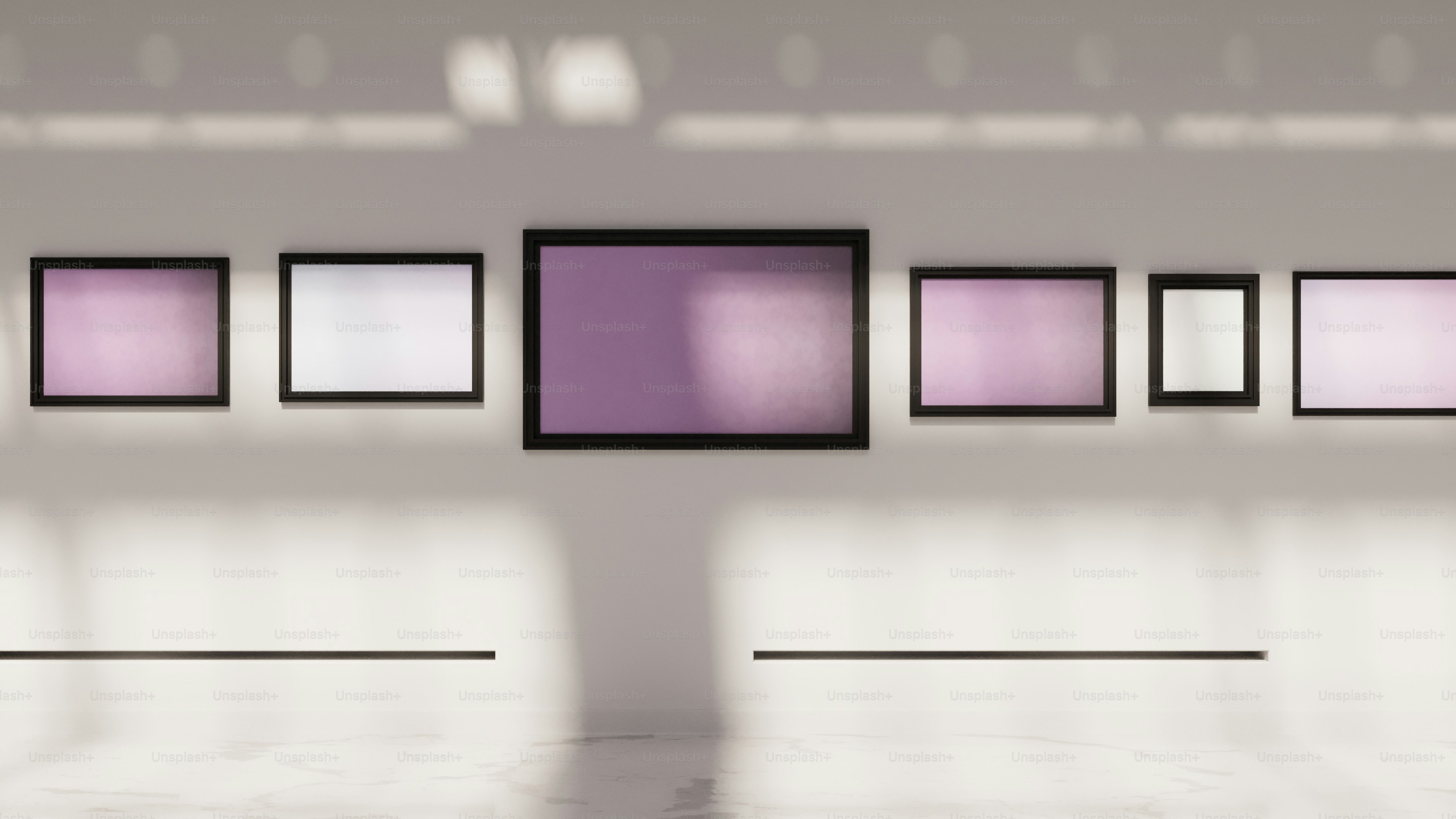 A wall with a bunch of frames hanging on it photo – Galery Image on ...