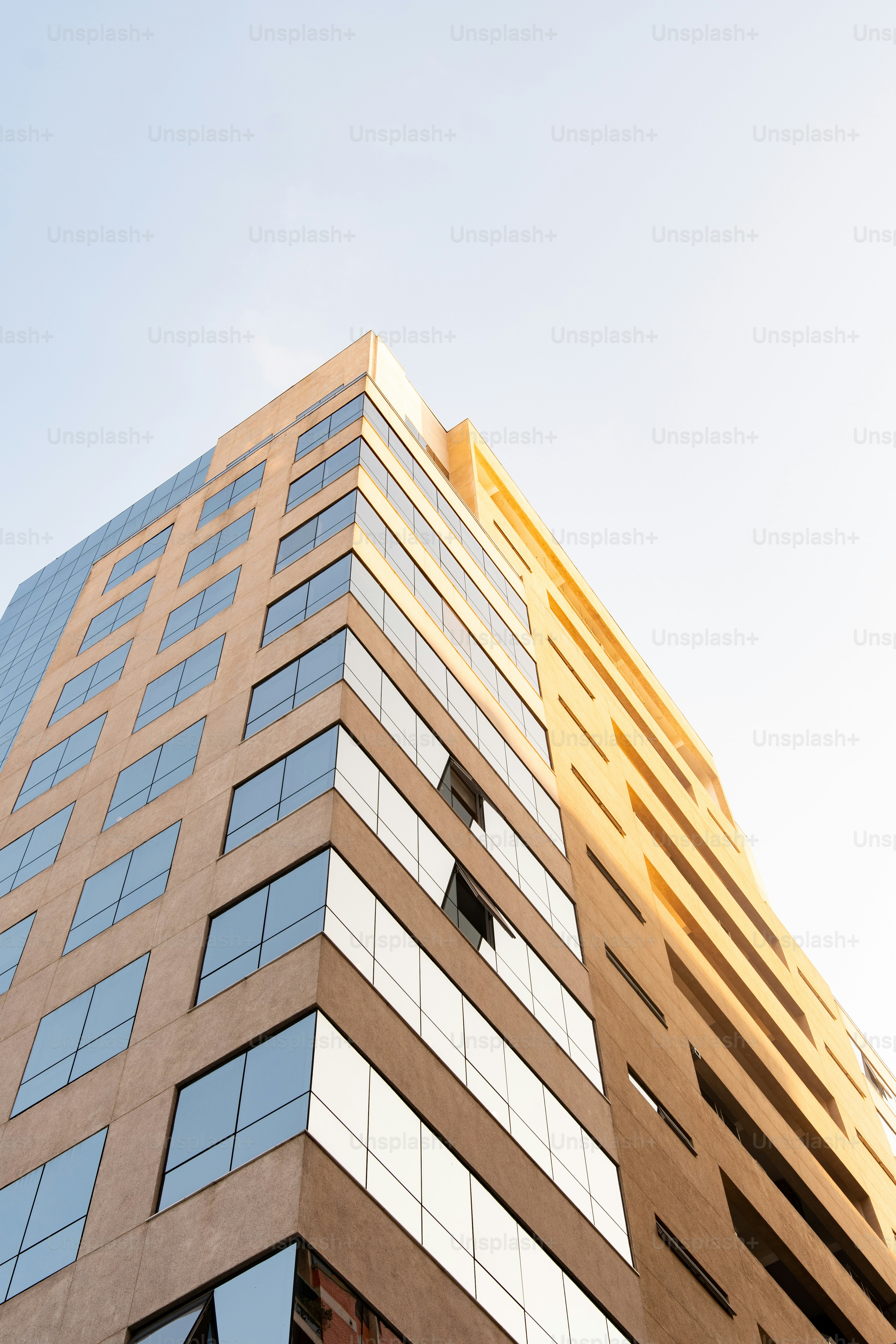 A tall brown building with lots of windows photo – Exterior Image on ...