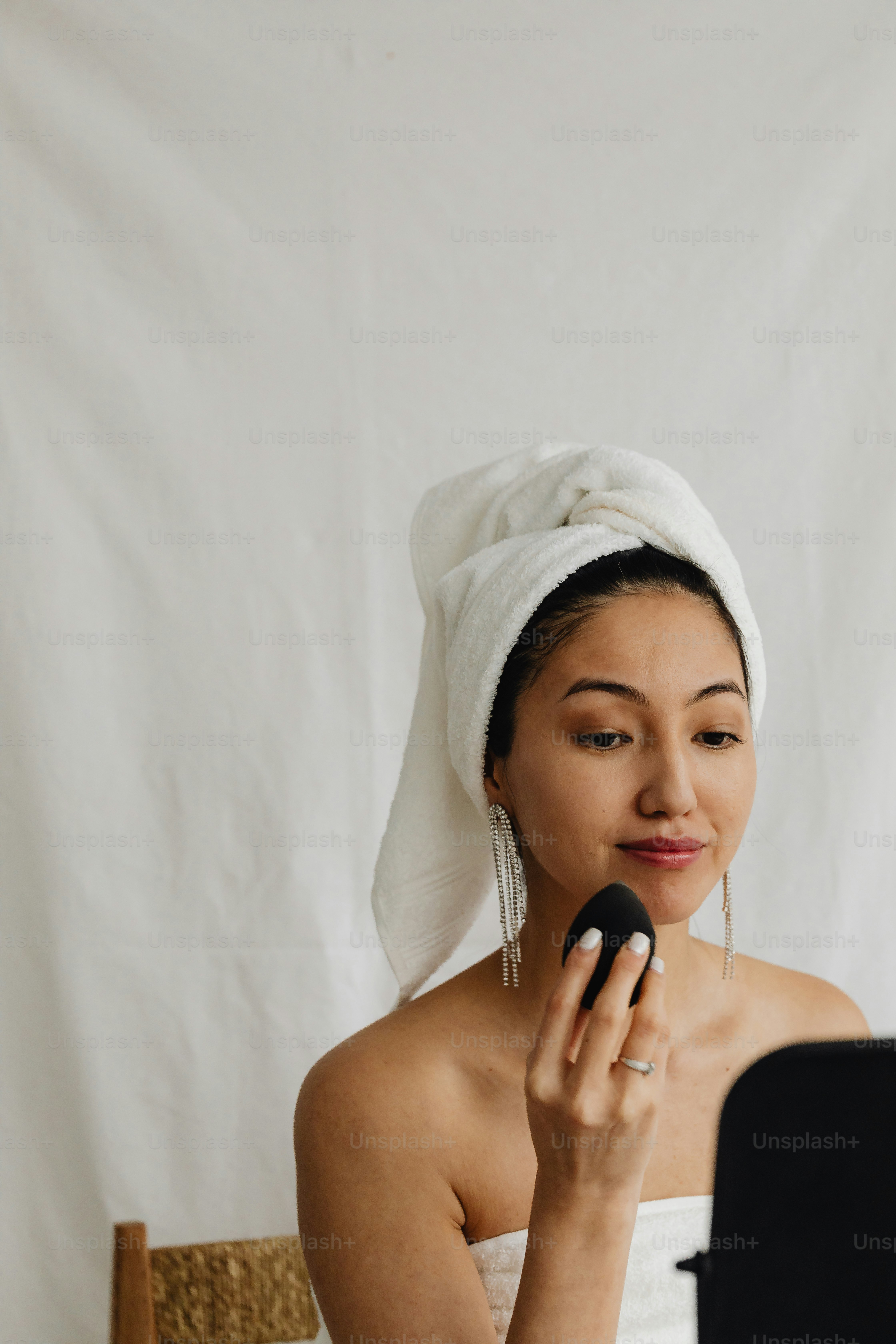 A woman with a towel on her head and a towel on her head photo ...