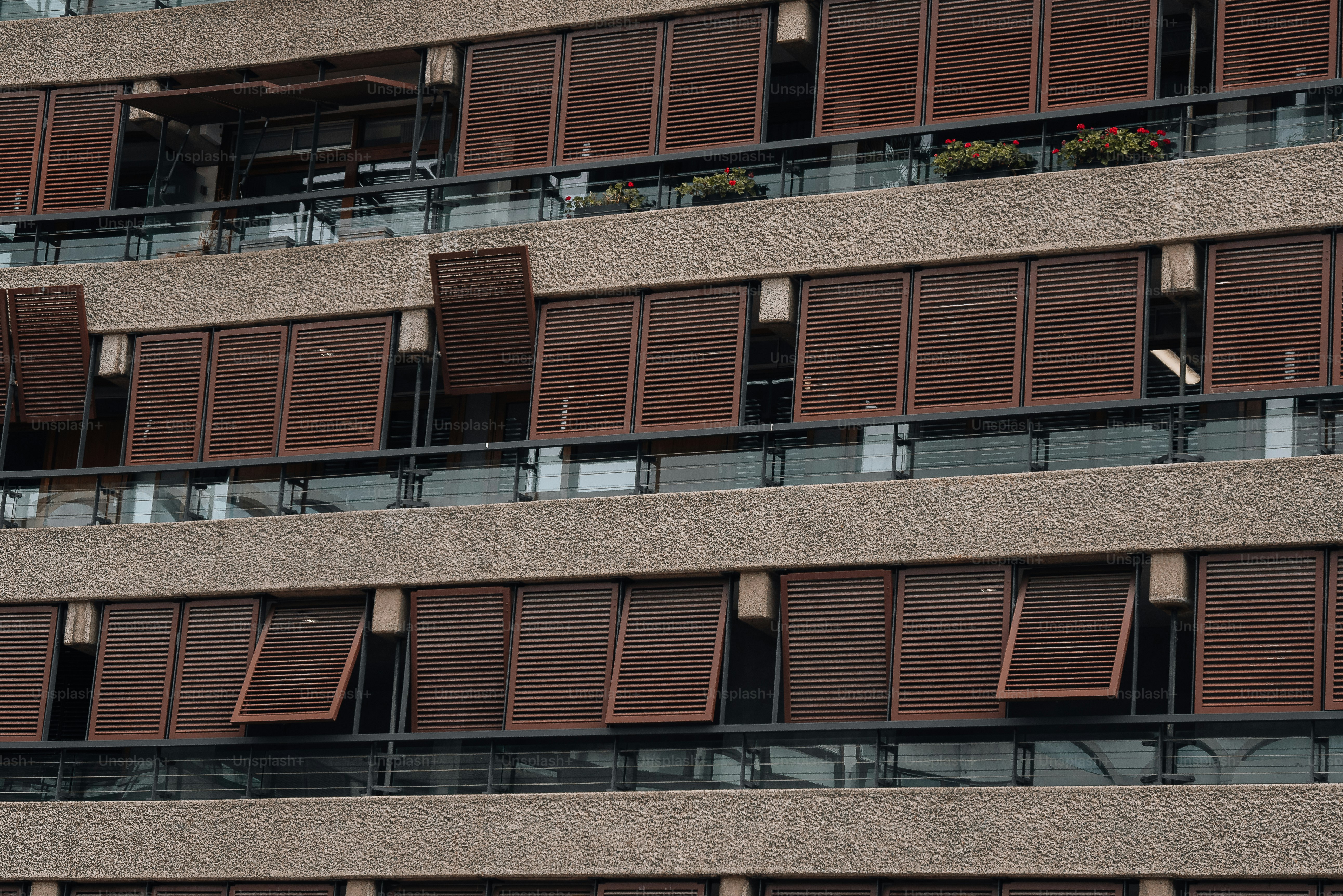 A tall building with lots of windows and wooden shutters photo ...