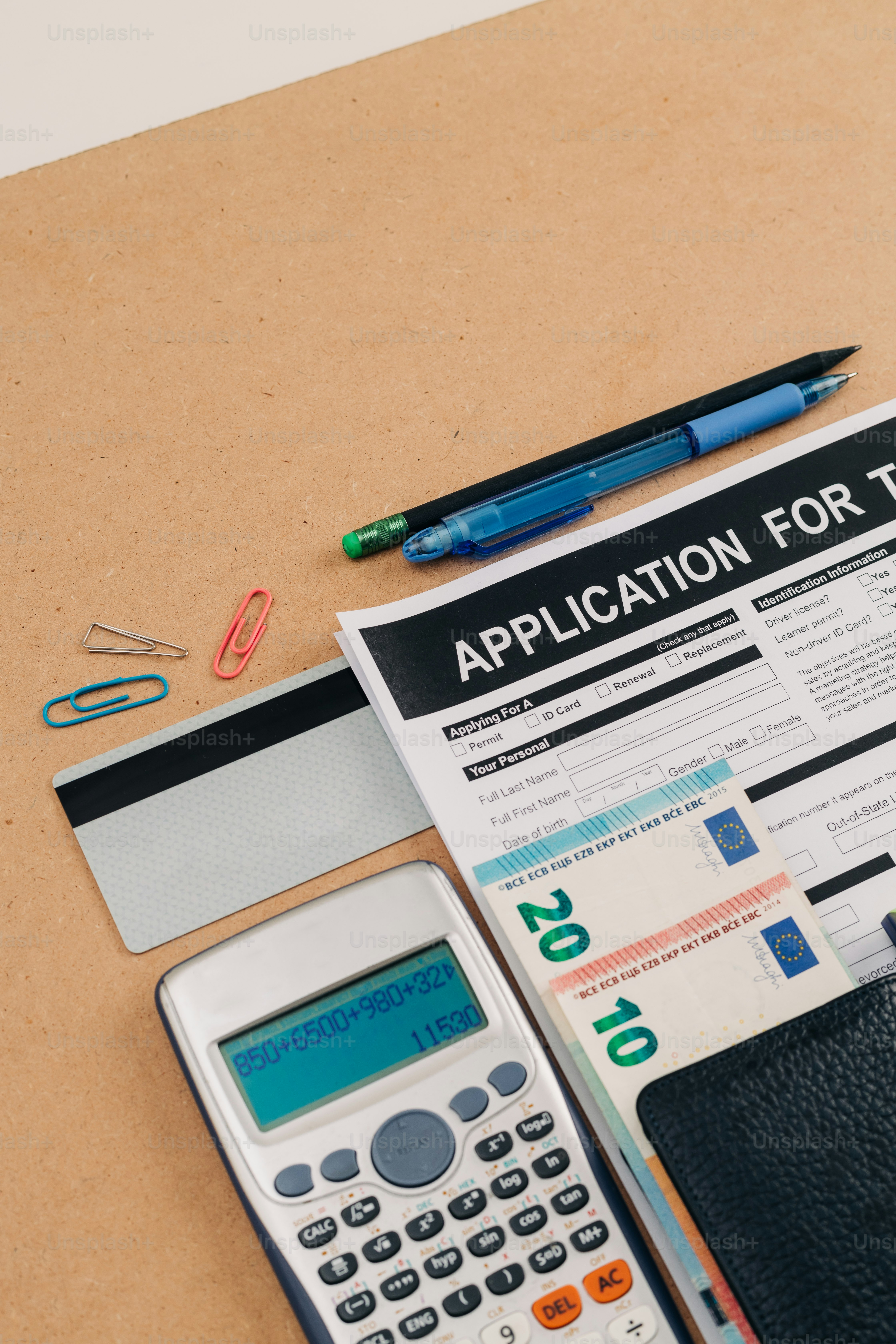 A tax form next to a calculator and a pen photo – Budgeting Image on ...