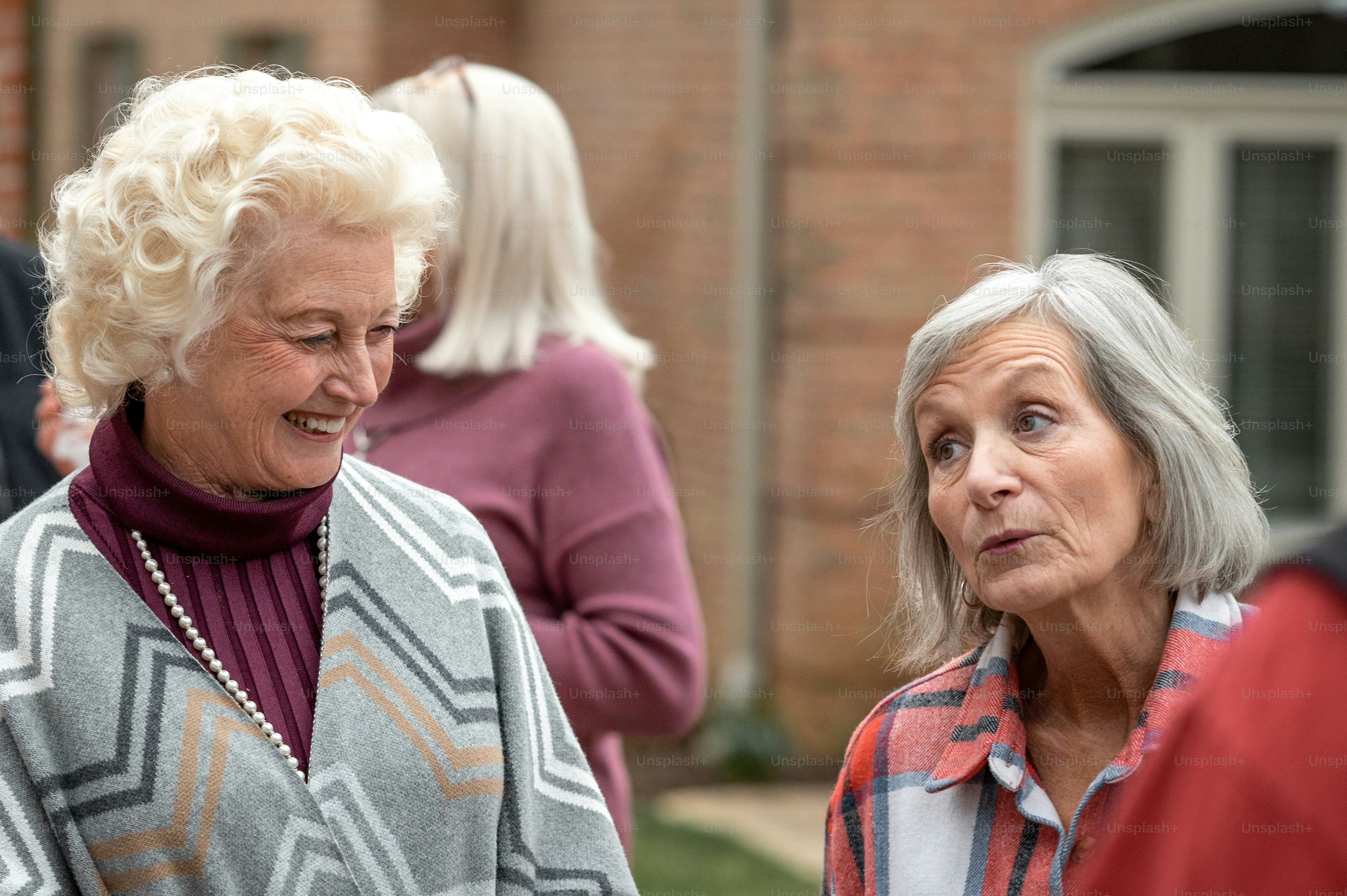 Two older women standing next to each other photo – Retirement Image on ...