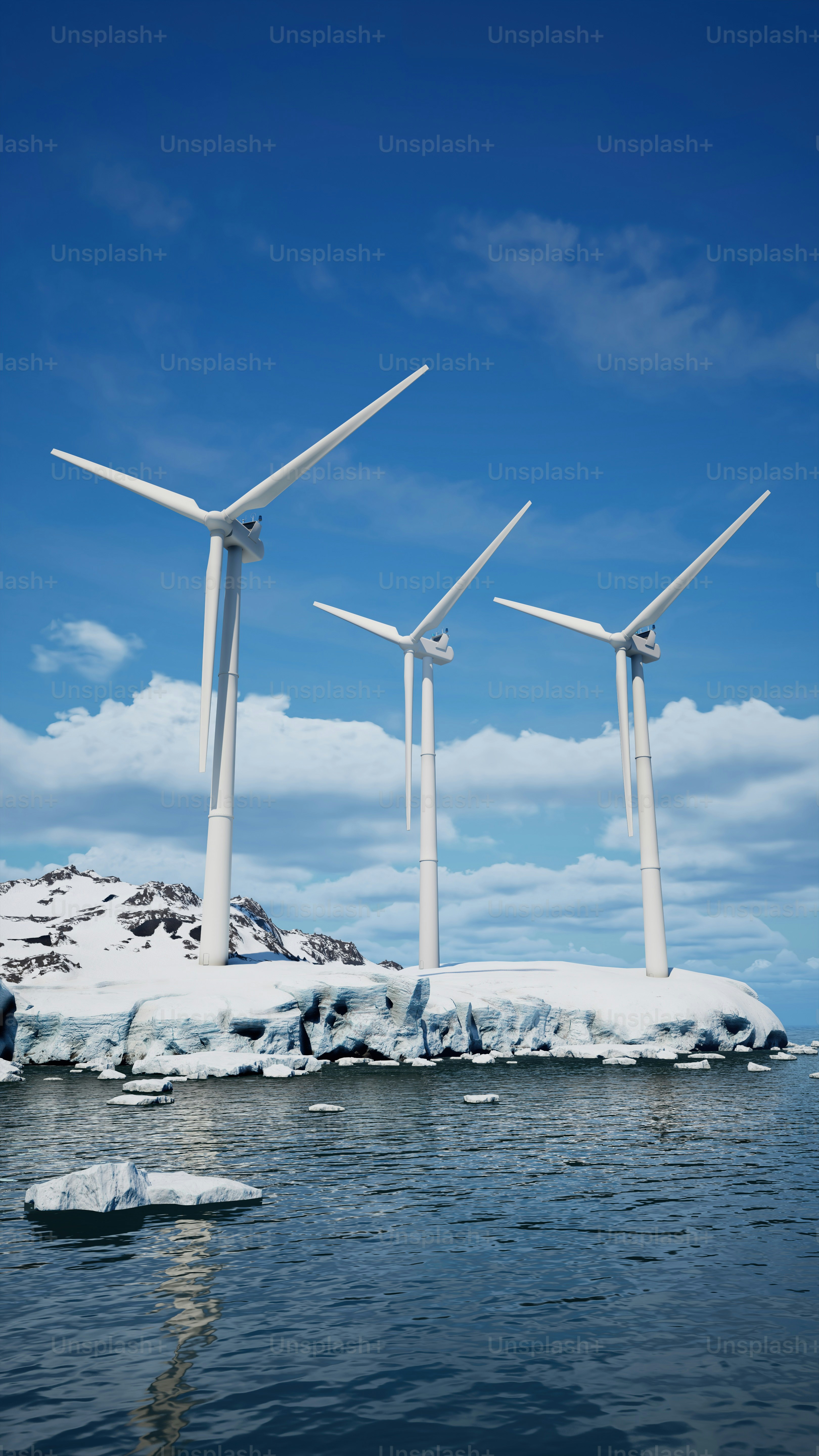 A group of wind turbines standing on top of a snow covered island photo ...