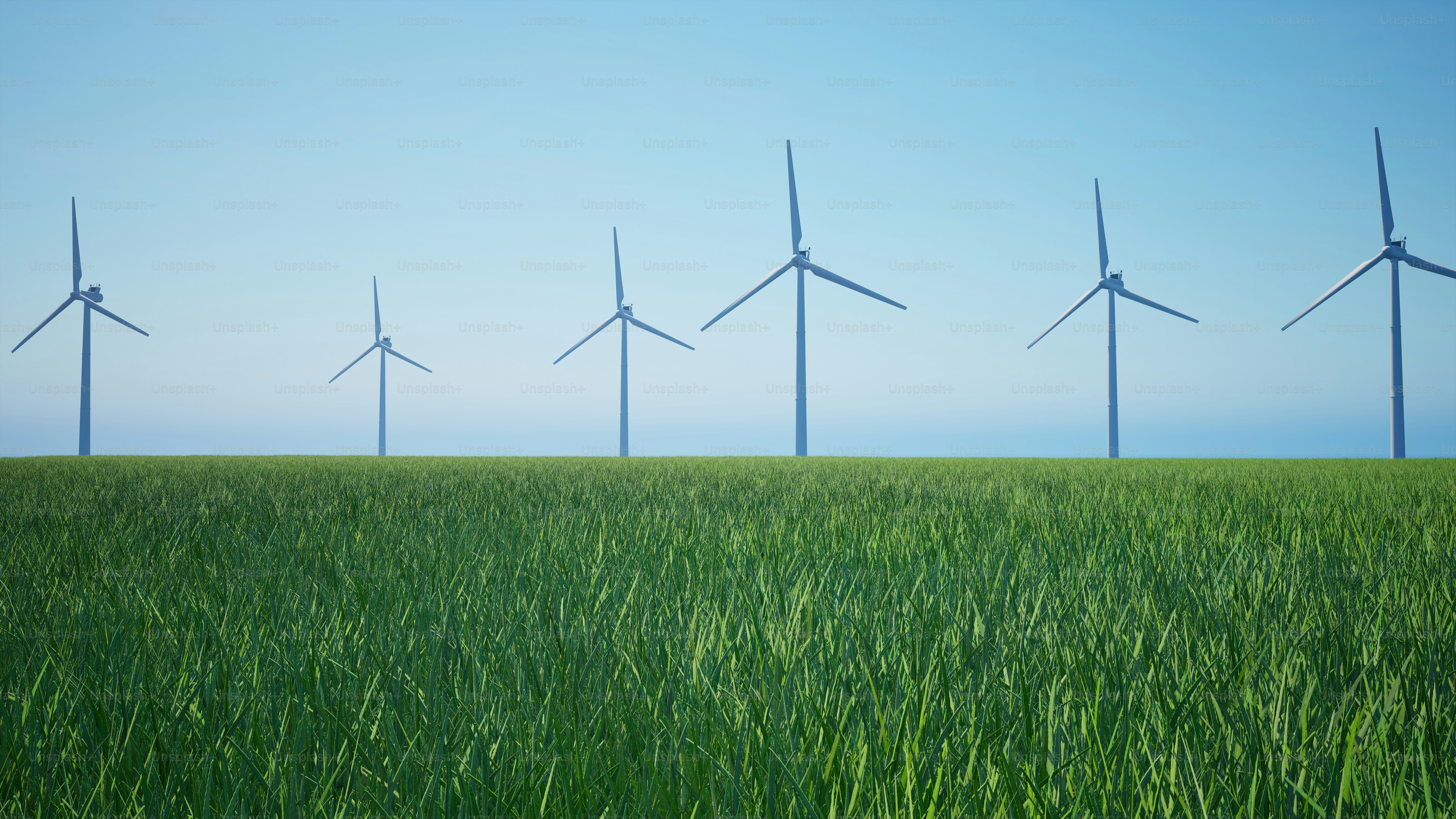 A row of wind turbines in a green field photo – Wind turbine Image on ...