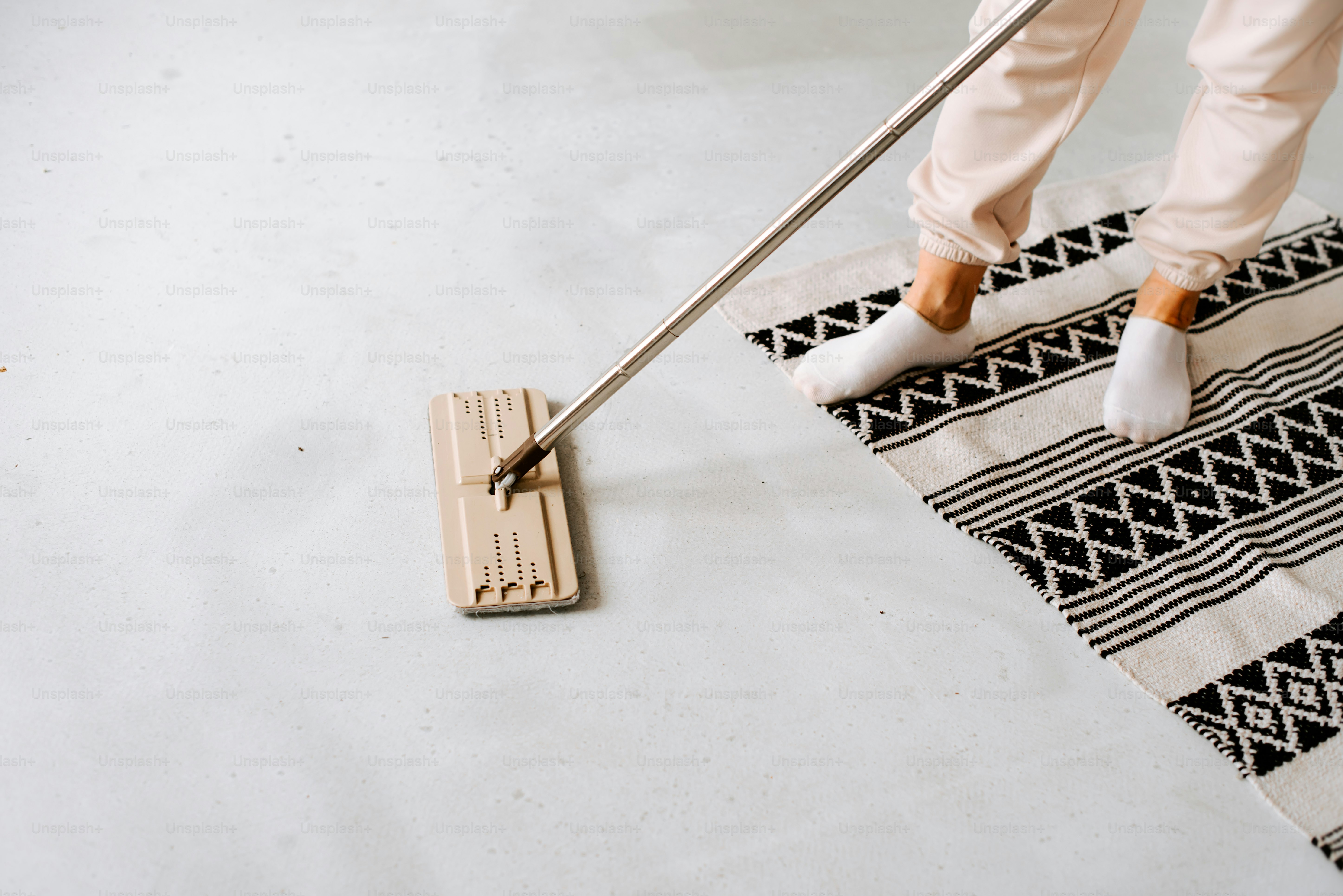 A person with a mop on a rug photo – Cleaner Image on Unsplash