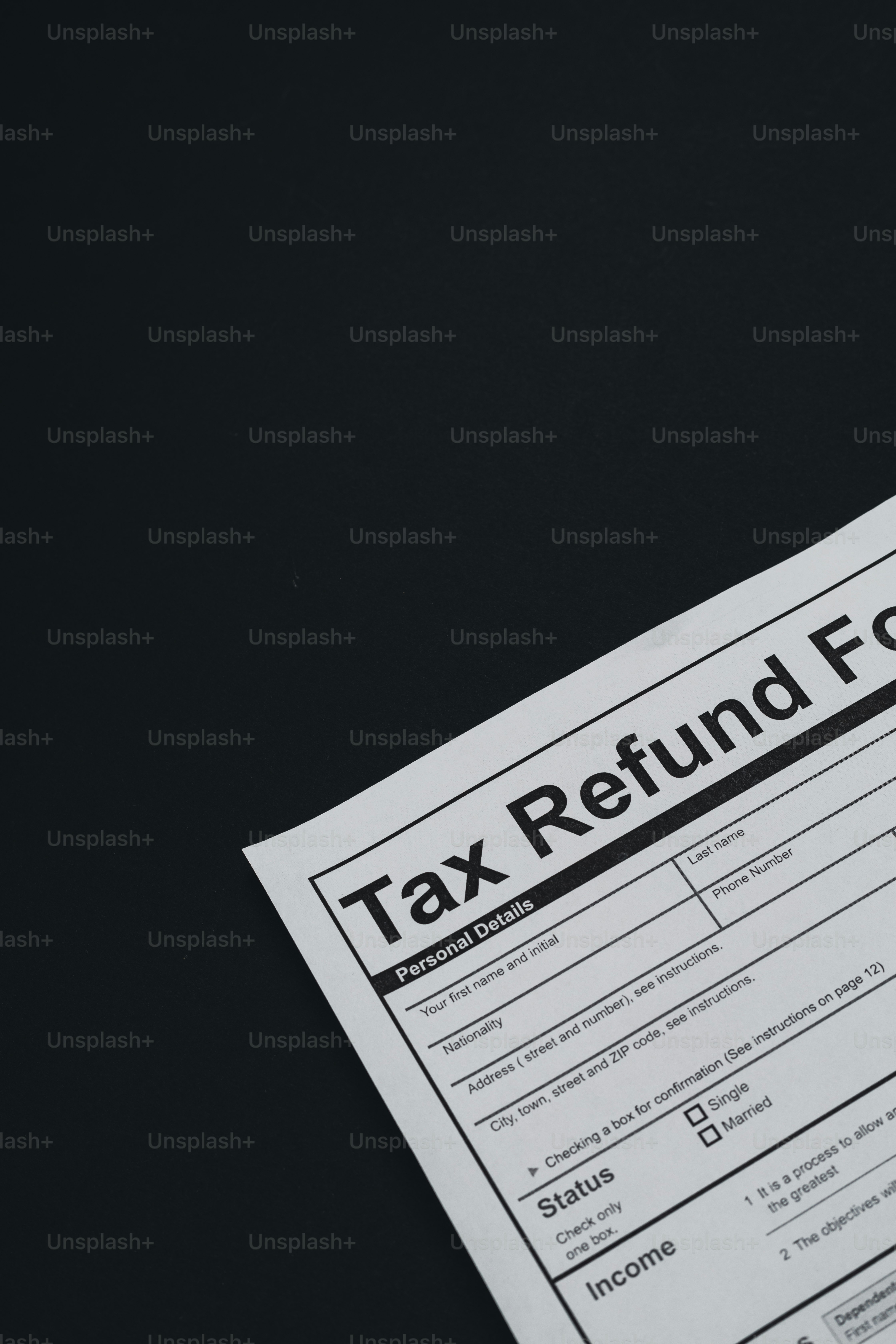 A tax refund form sitting on top of a table photo – Financial Image on ...