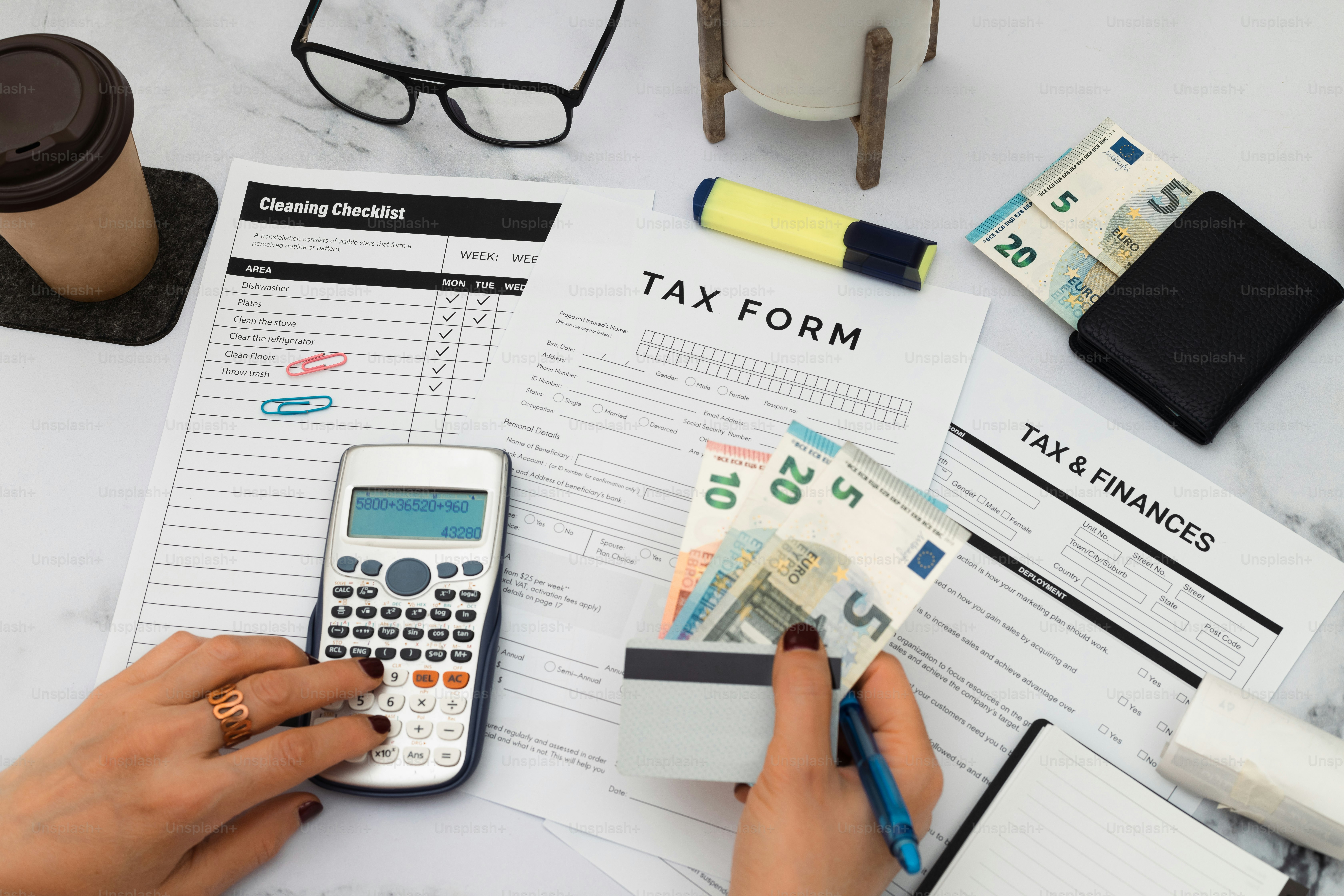 A person holding a calculator next to a tax form photo – Finance Image ...