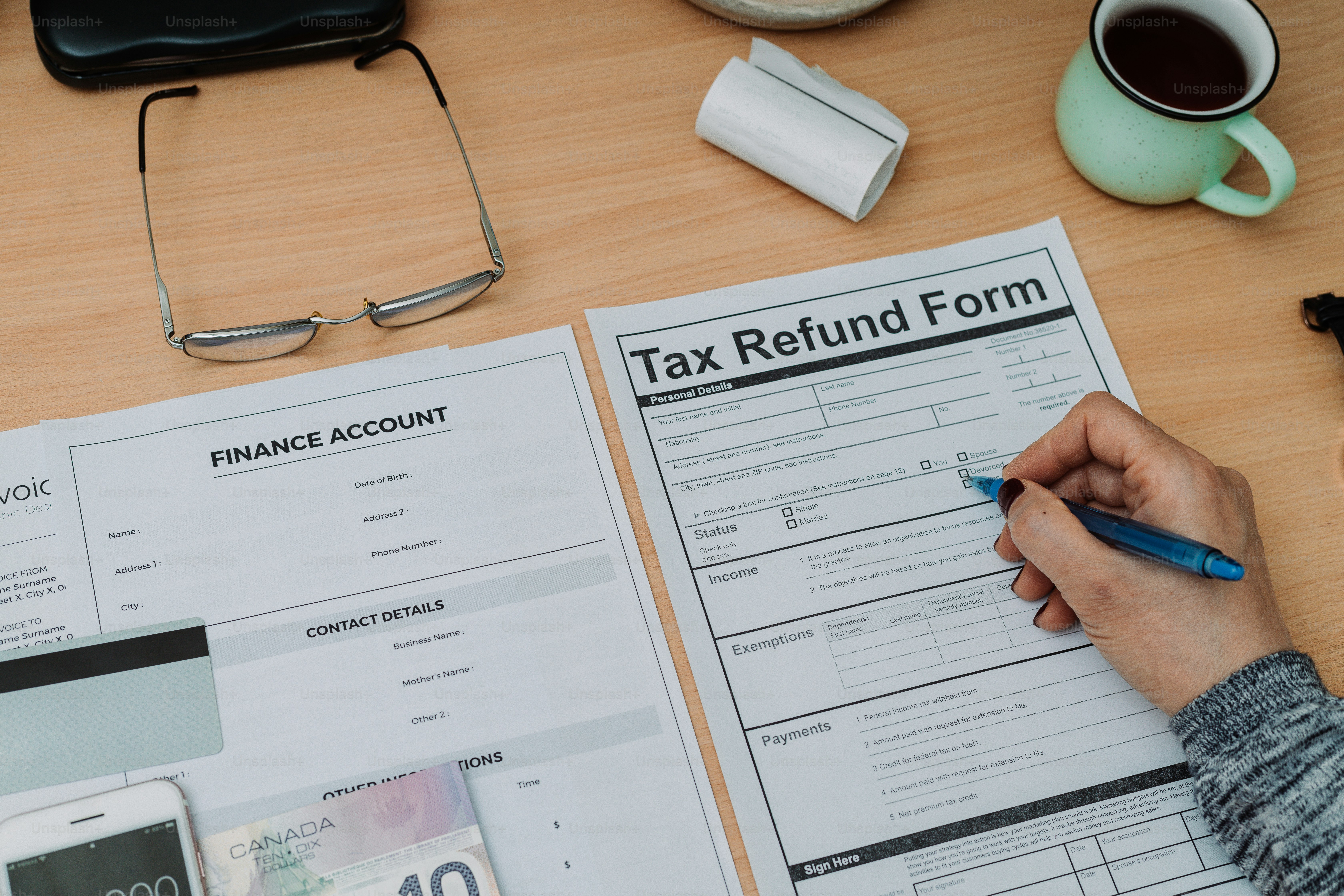 A person filling out a tax return form photo – Accounting Image on Unsplash