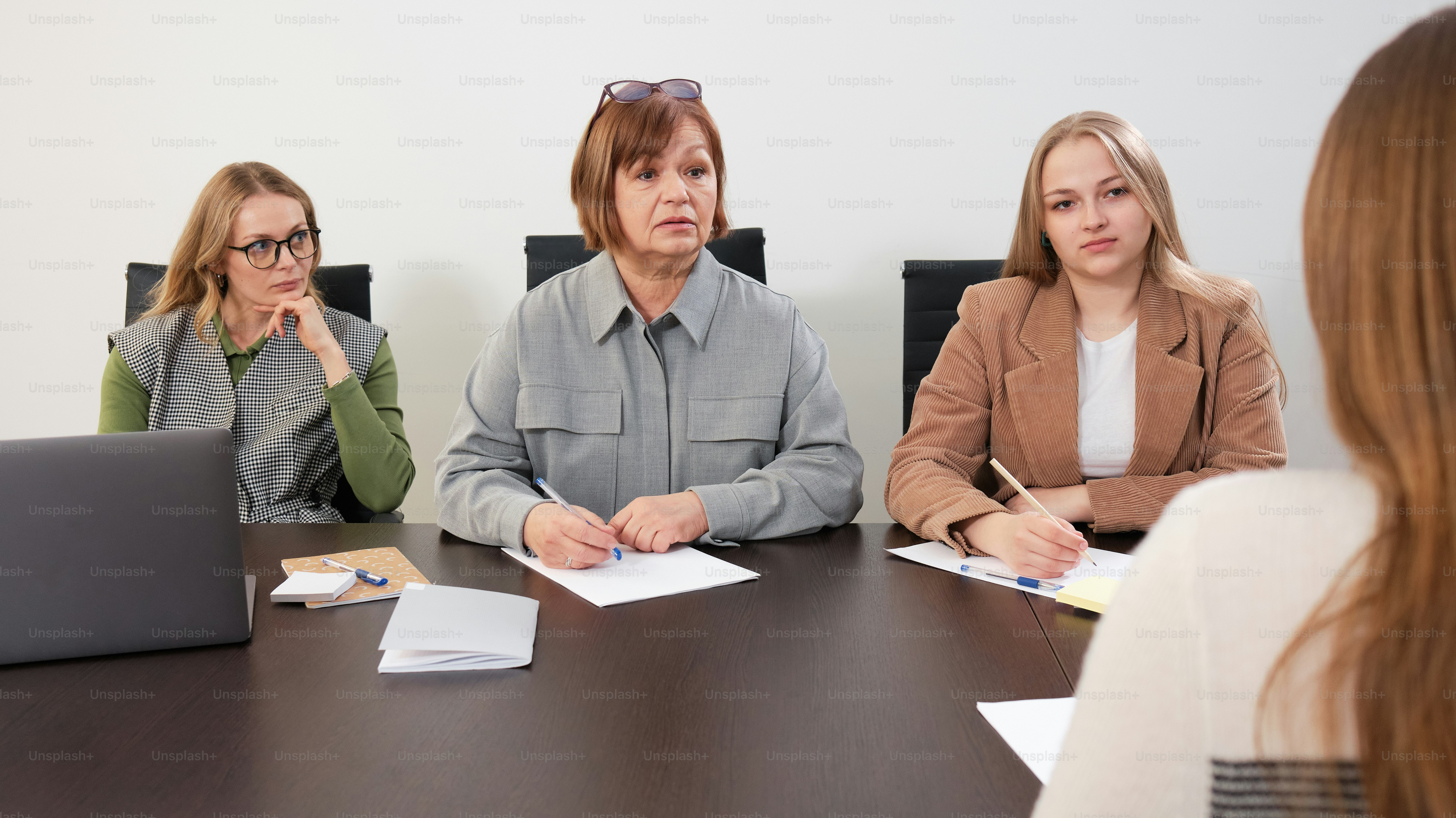 A group of women sitting around a table talking photo – Job interview ...