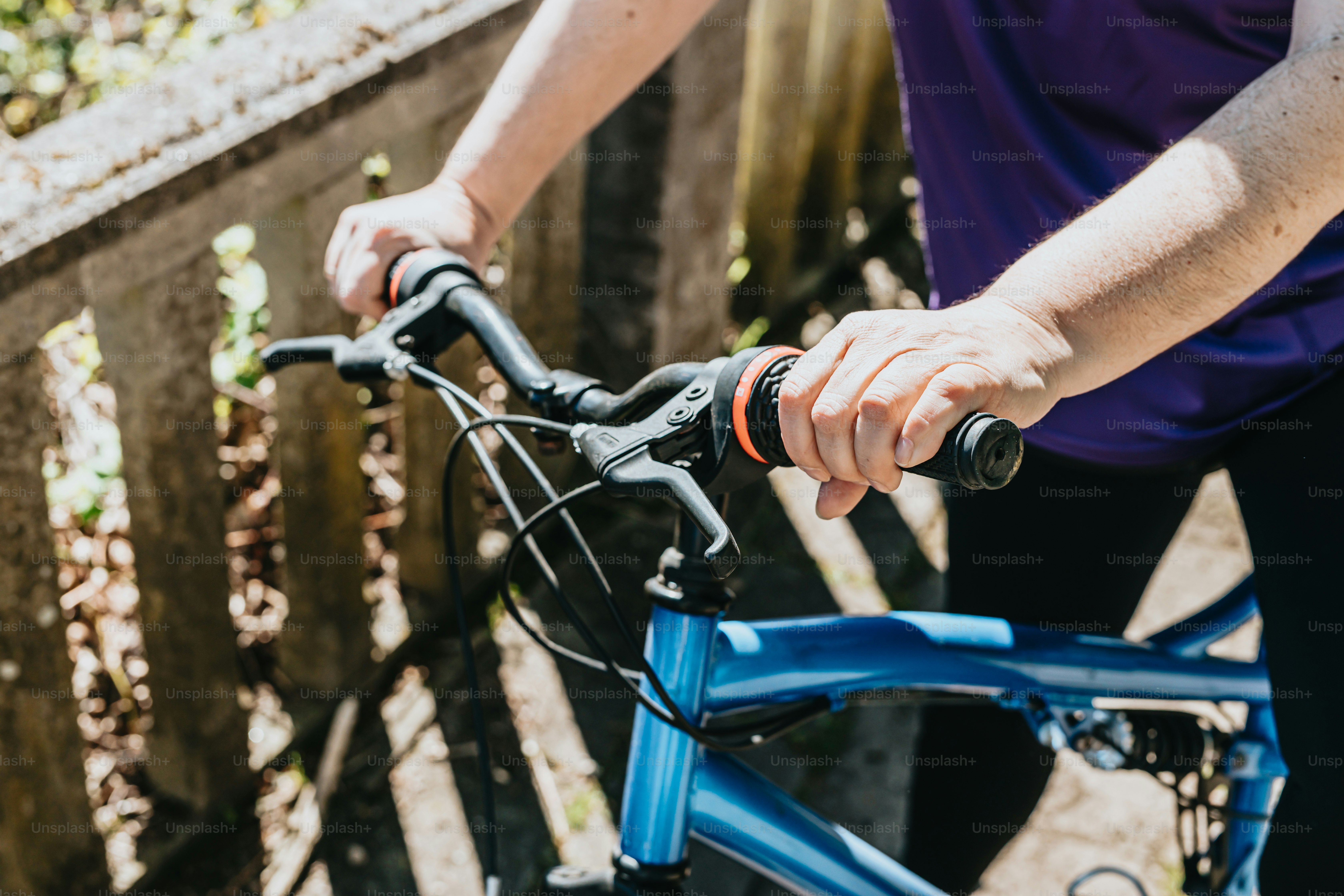 A man riding a bike down a dirt road photo – Biking Image on Unsplash