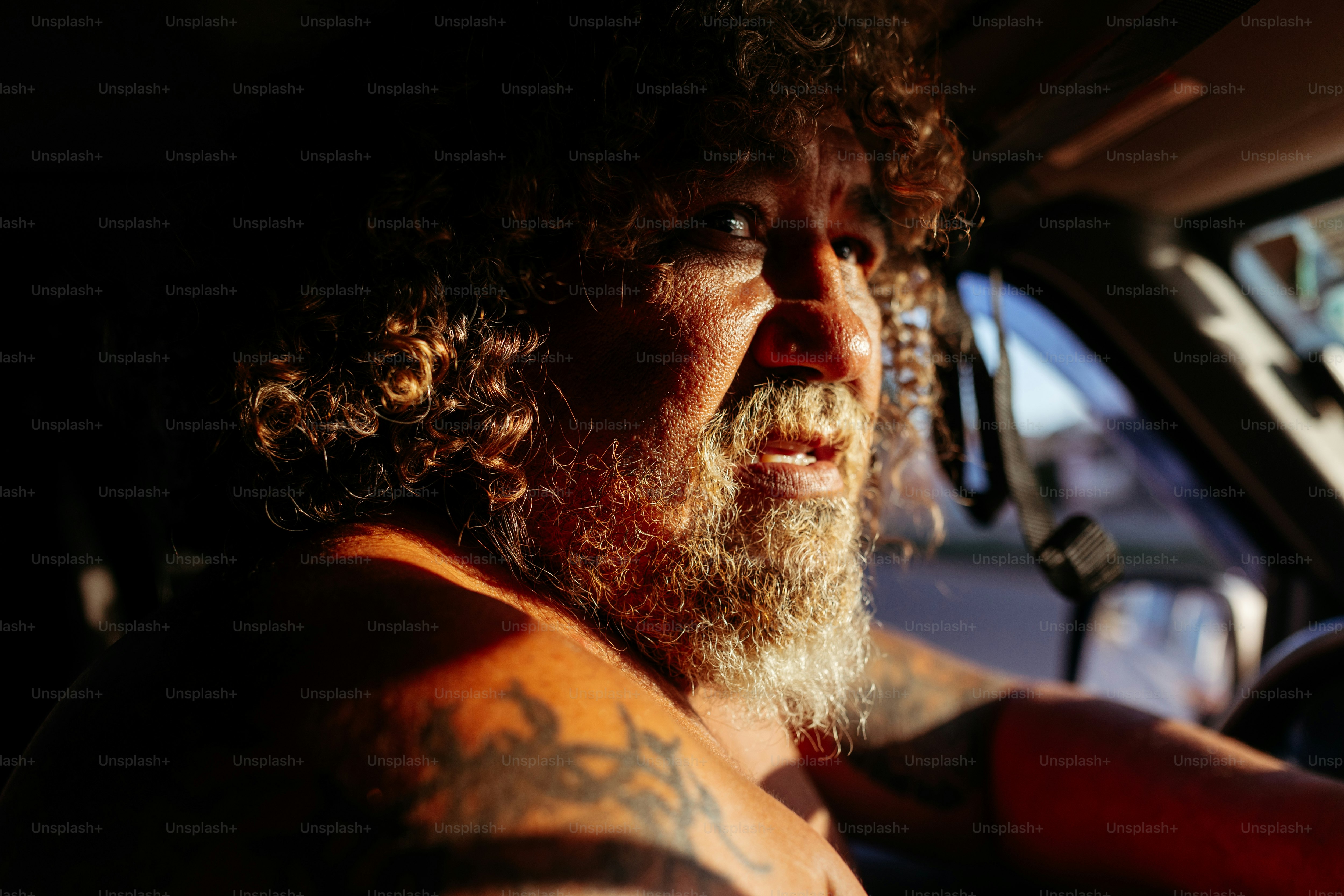 A man with a beard driving a car photo – Senior man Image on Unsplash