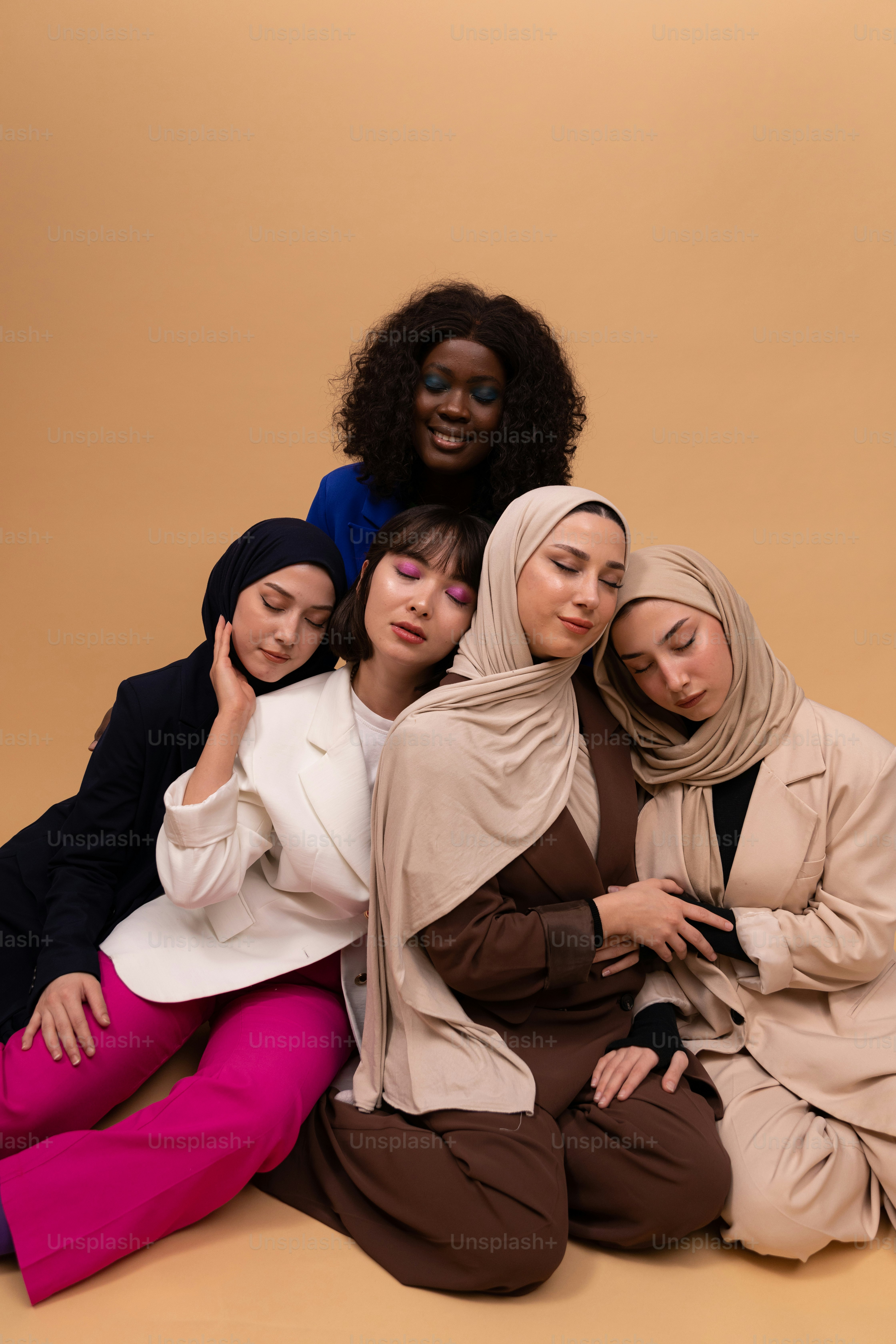 A group of women sitting next to each other photo – Women's rights ...