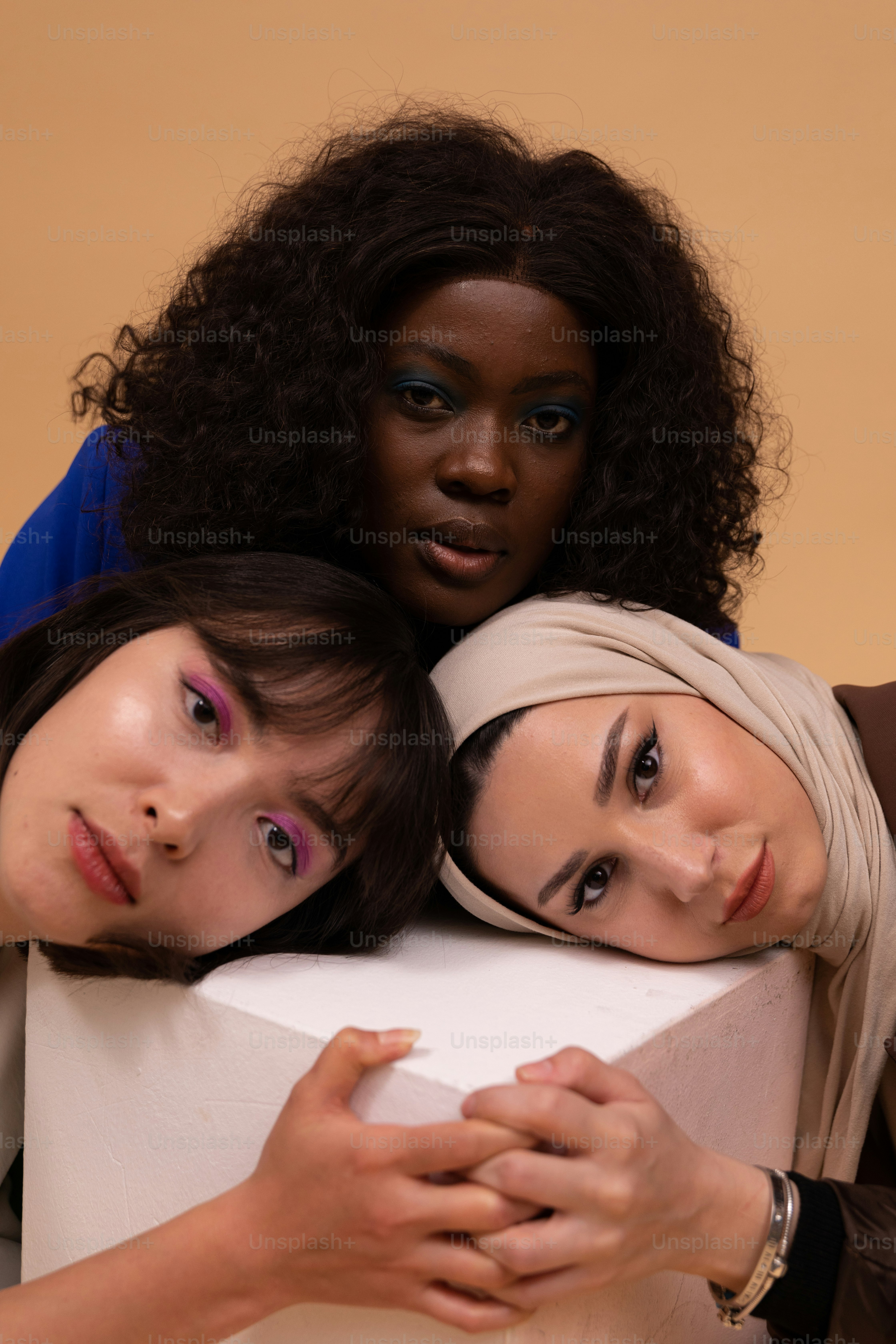 Three women posing for a picture with their arms around each other ...