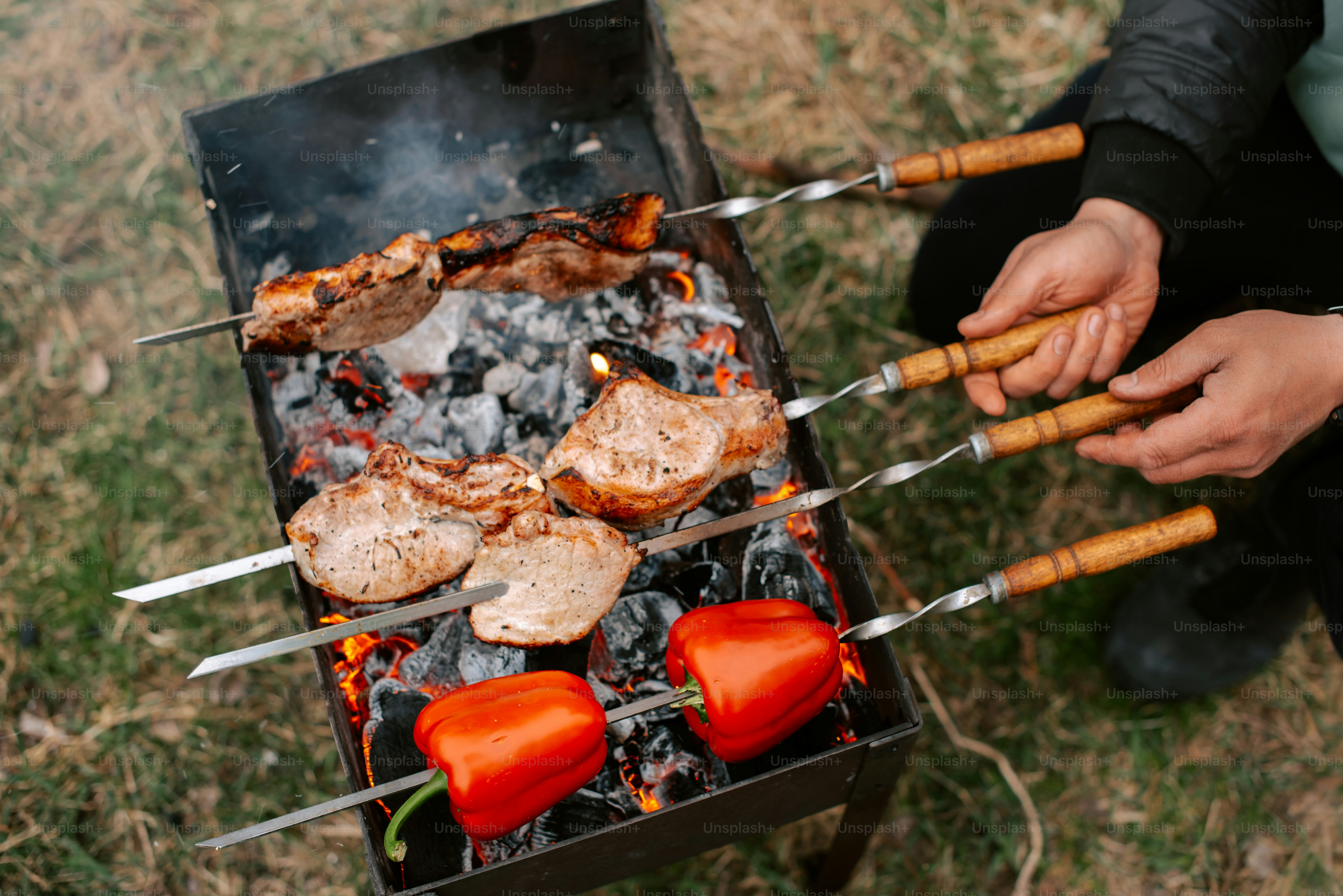 A person is cooking food on a grill photo – Barbeque Image on Unsplash