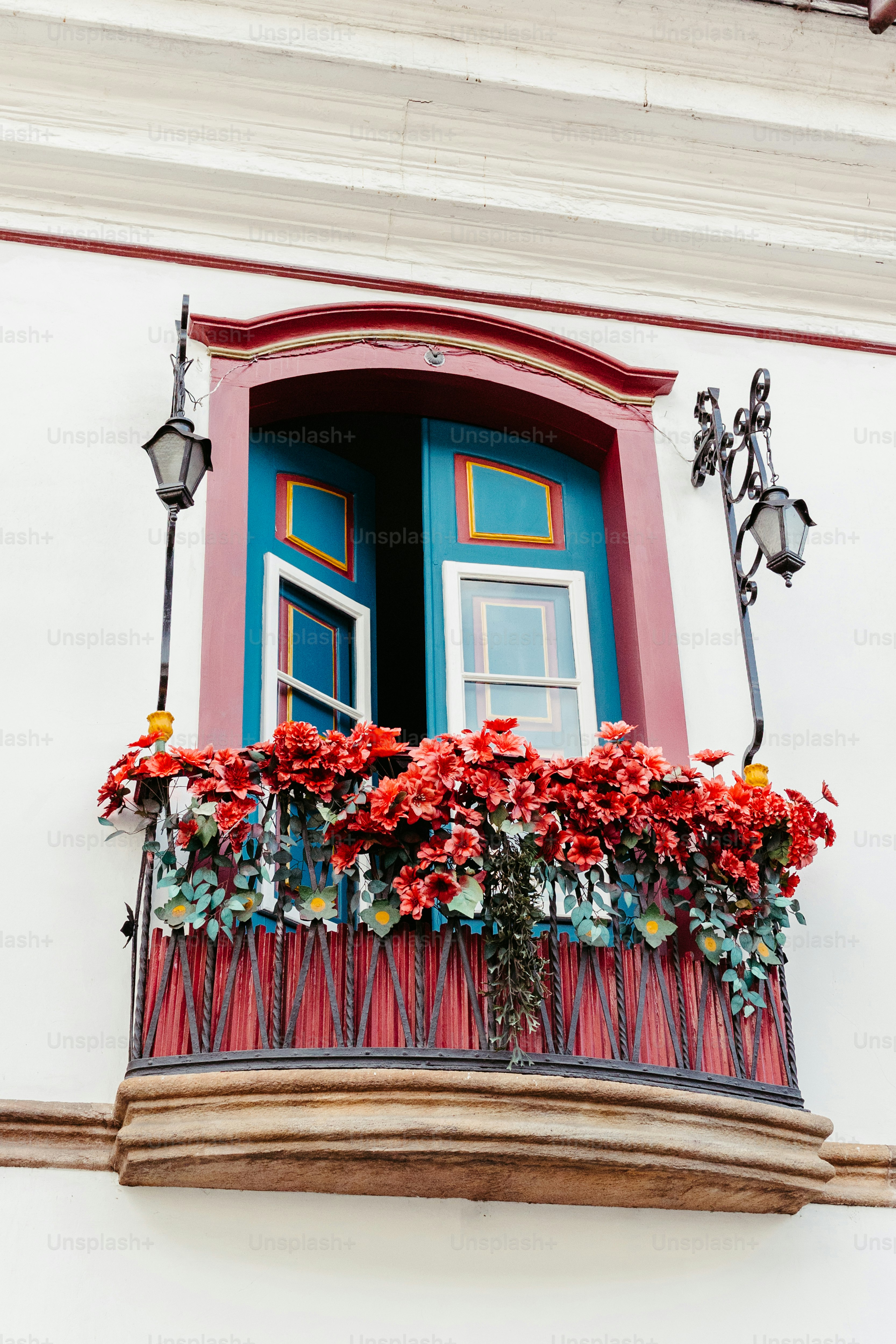 A red and blue window box with flowers on it photo – Flower bed Image ...