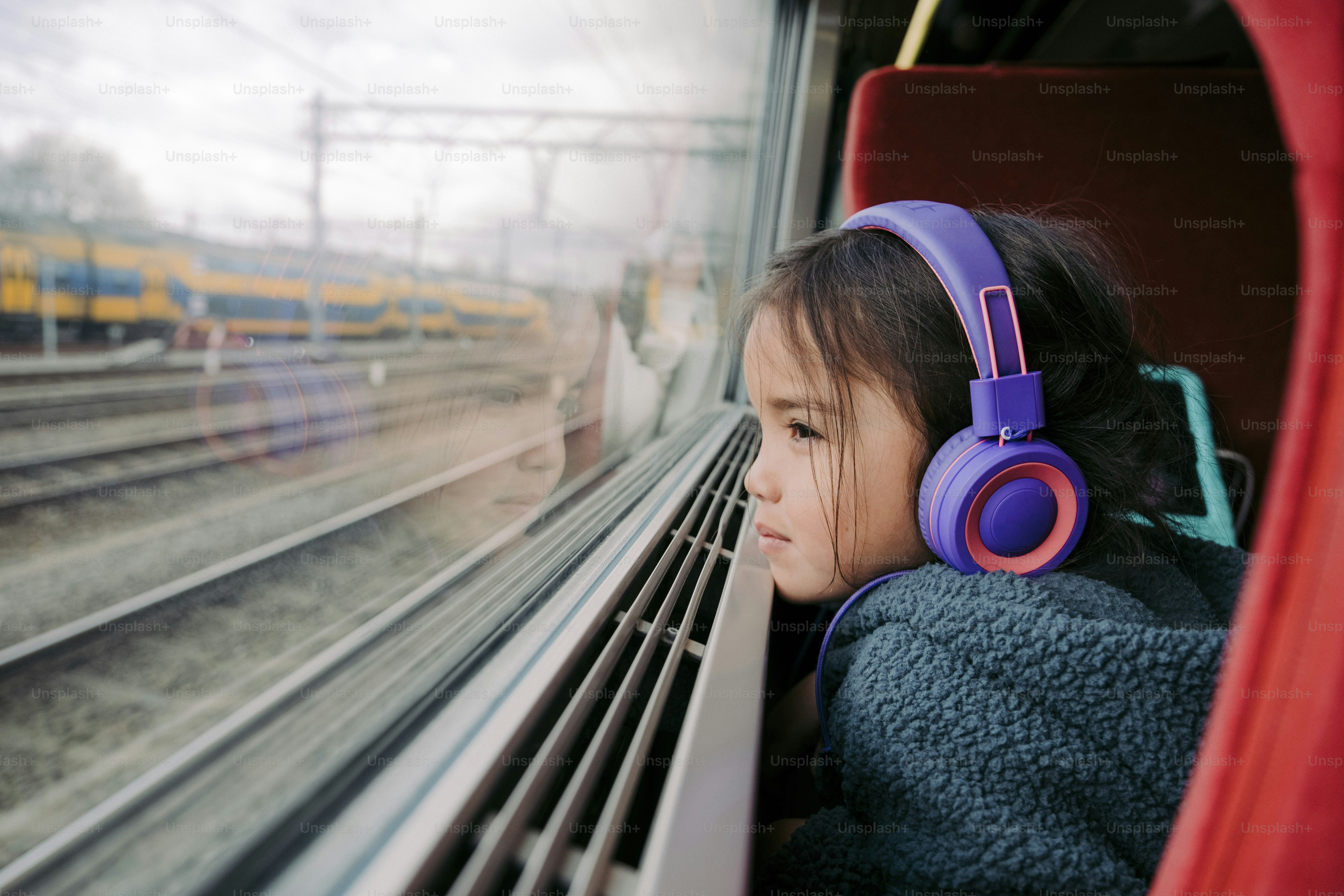 A woman looking out the window of a train photo – Train Image on Unsplash