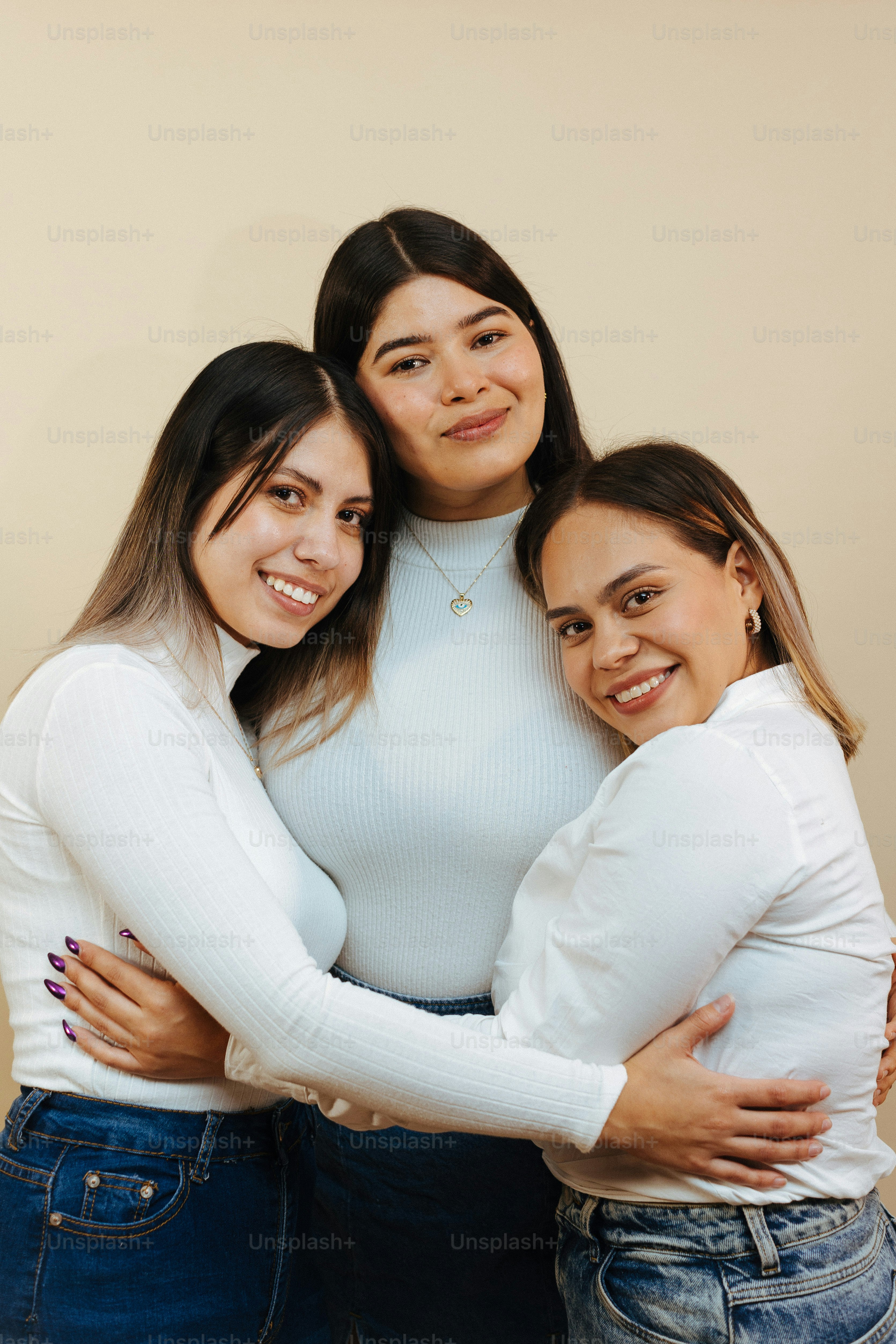 Three women hugging each other in a room photo – Fashion Image on Unsplash
