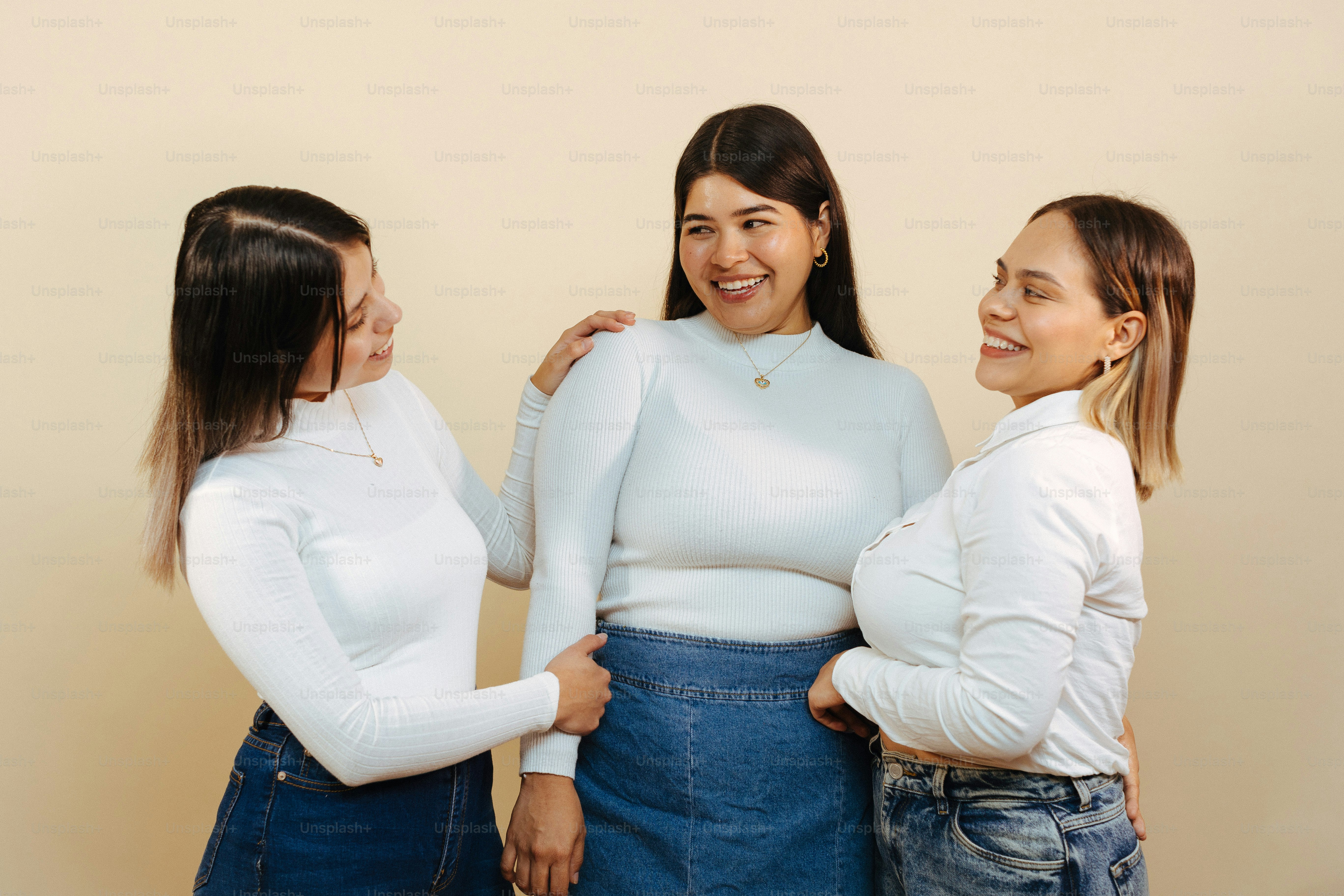 A group of three women standing next to each other photo – Fashion ...