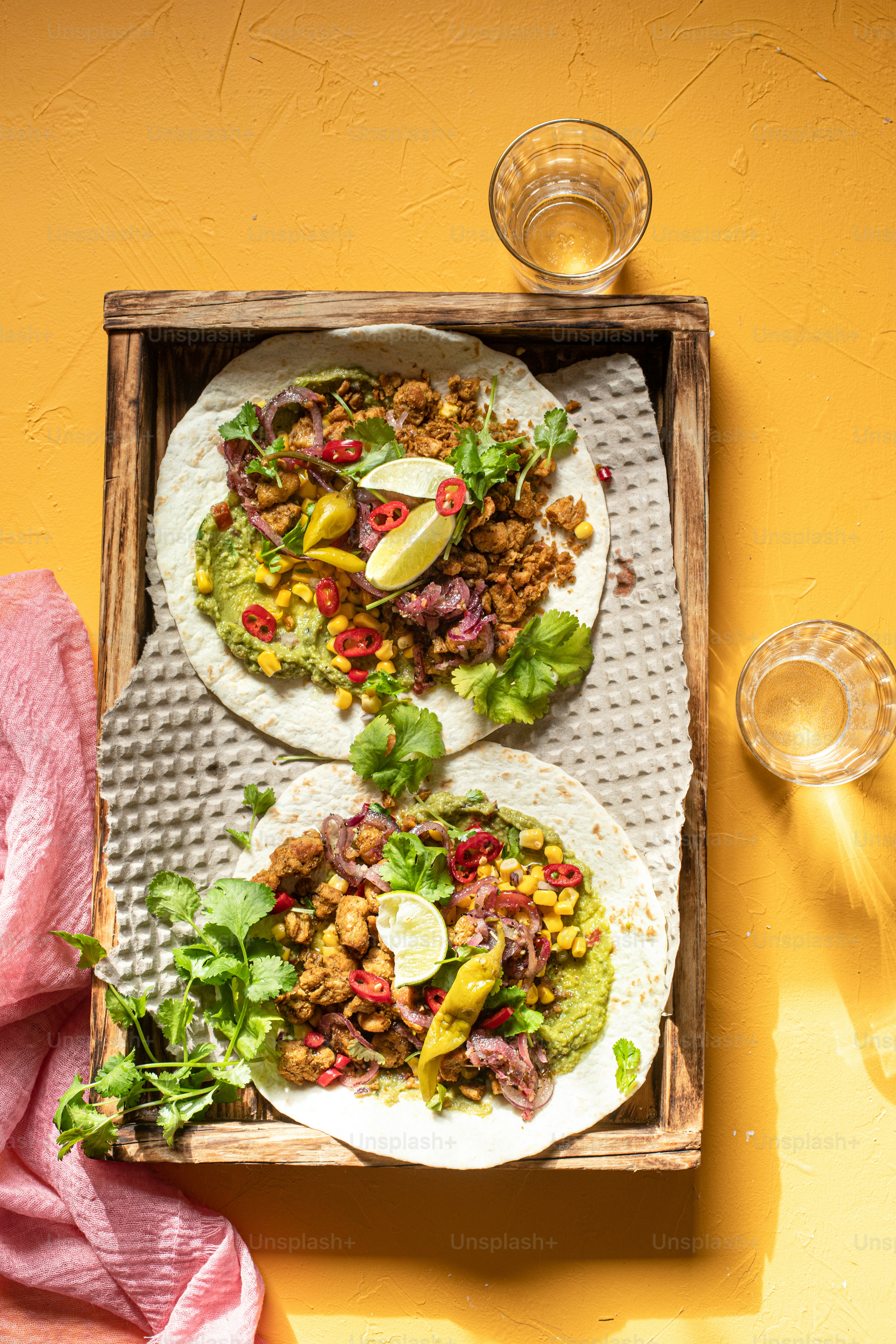 A couple of tacos sitting on top of a table photo – Mexico Image on ...