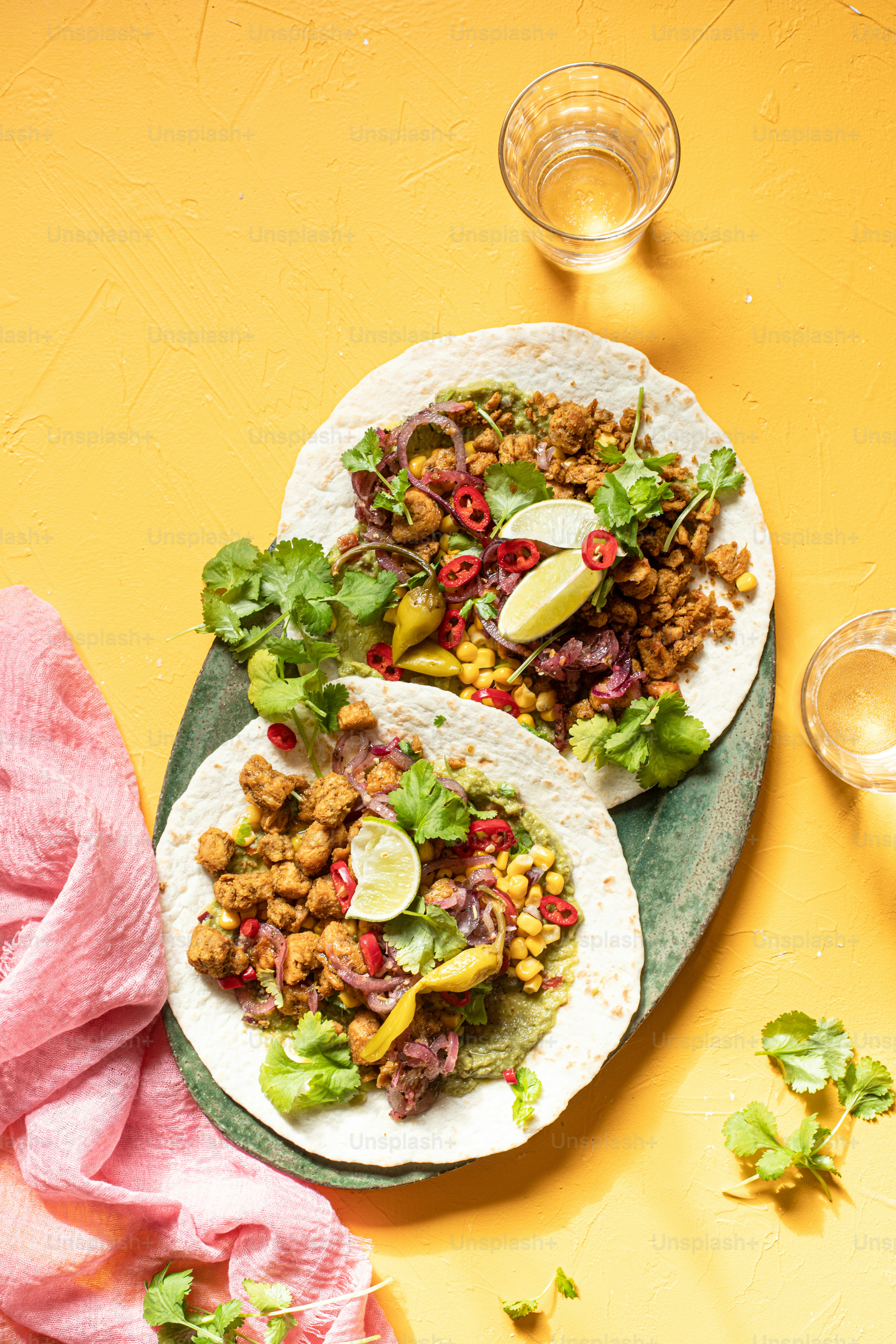 A couple of tacos sitting on top of a plate photo – Mexico Image on ...