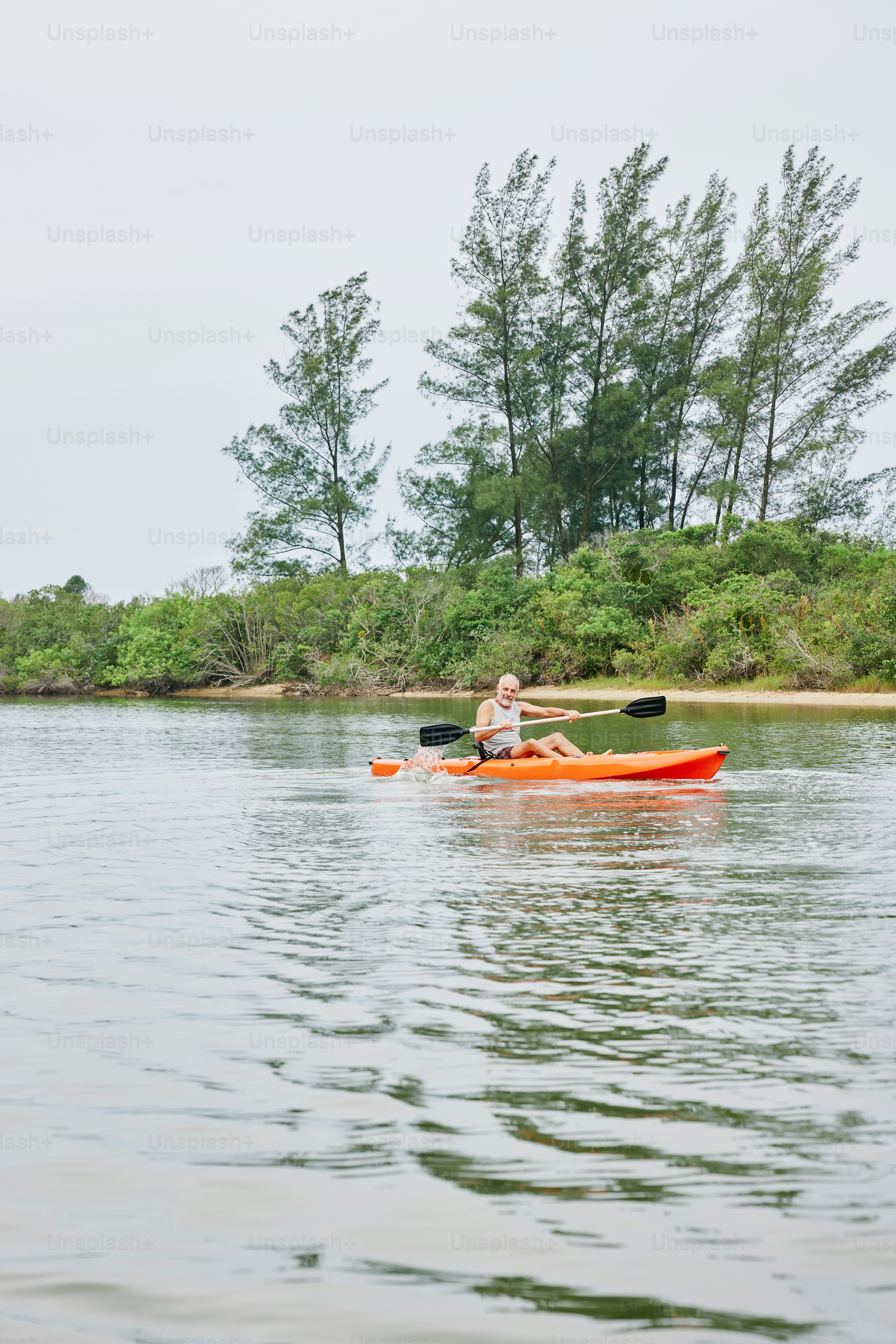 A woman is paddling a kayak on the water photo – Kayak Image on Unsplash