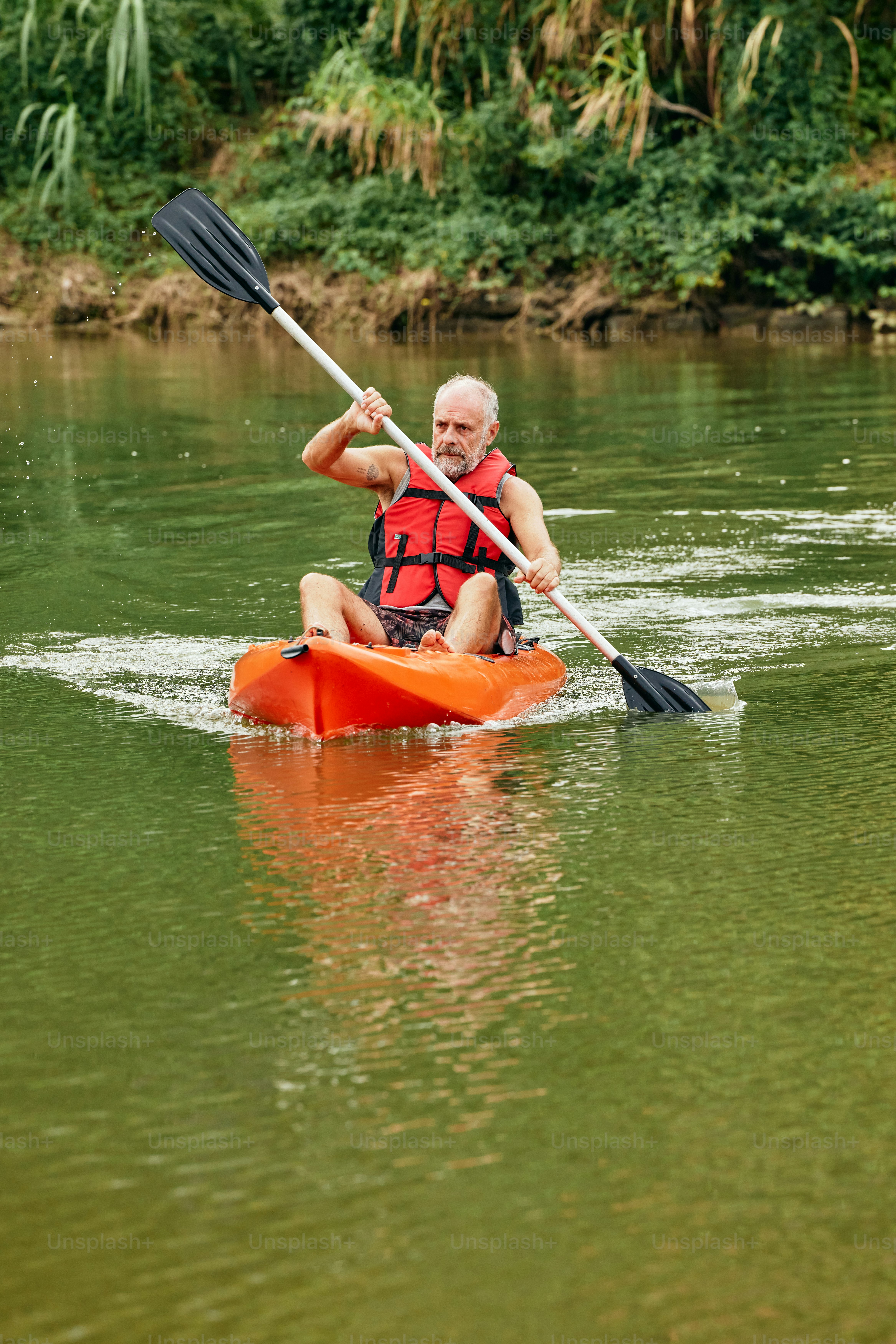 A man in a life jacket paddling a kayak photo – Senior Image on Unsplash