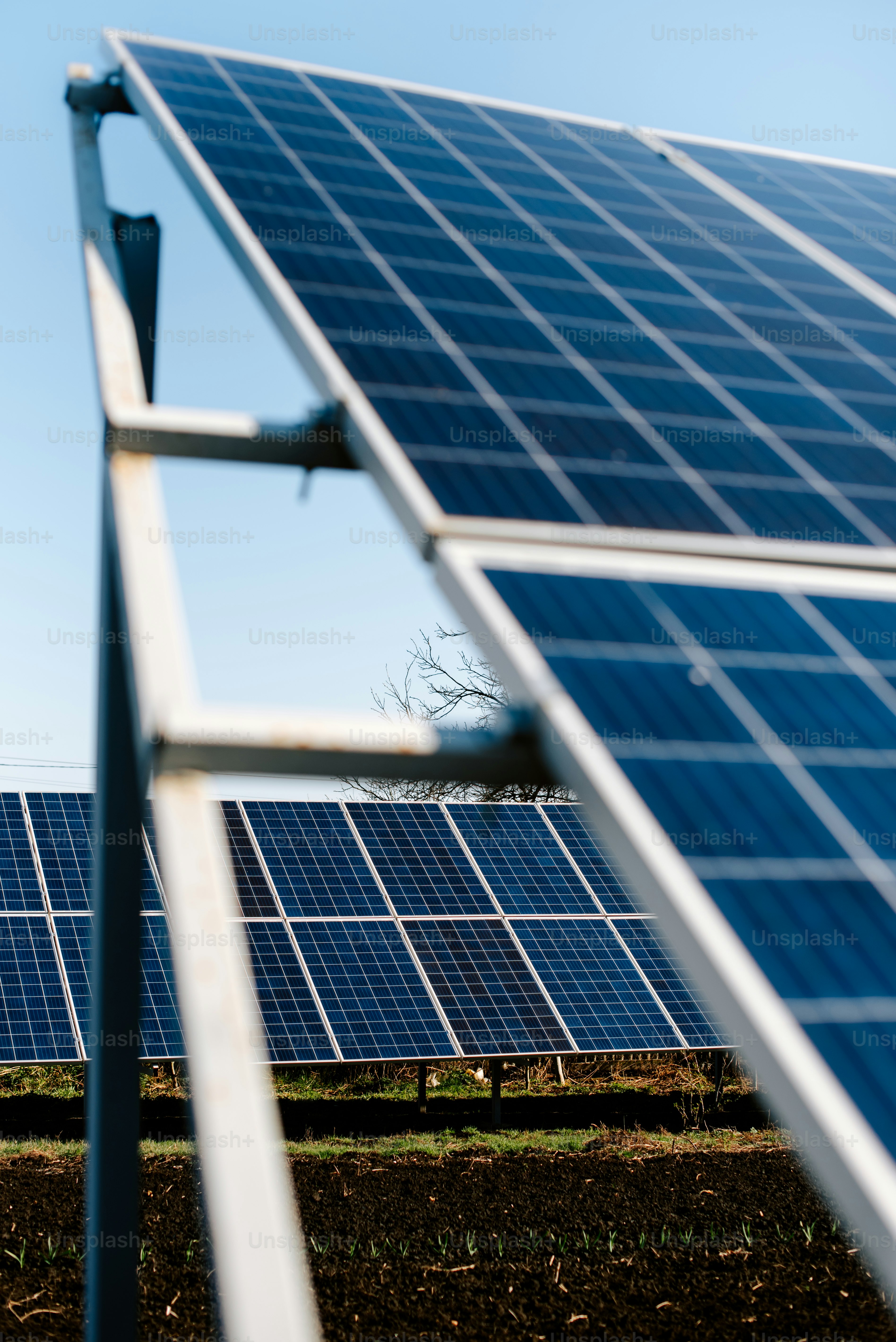 A row of solar panels in a field photo – Renewable energy Image on Unsplash