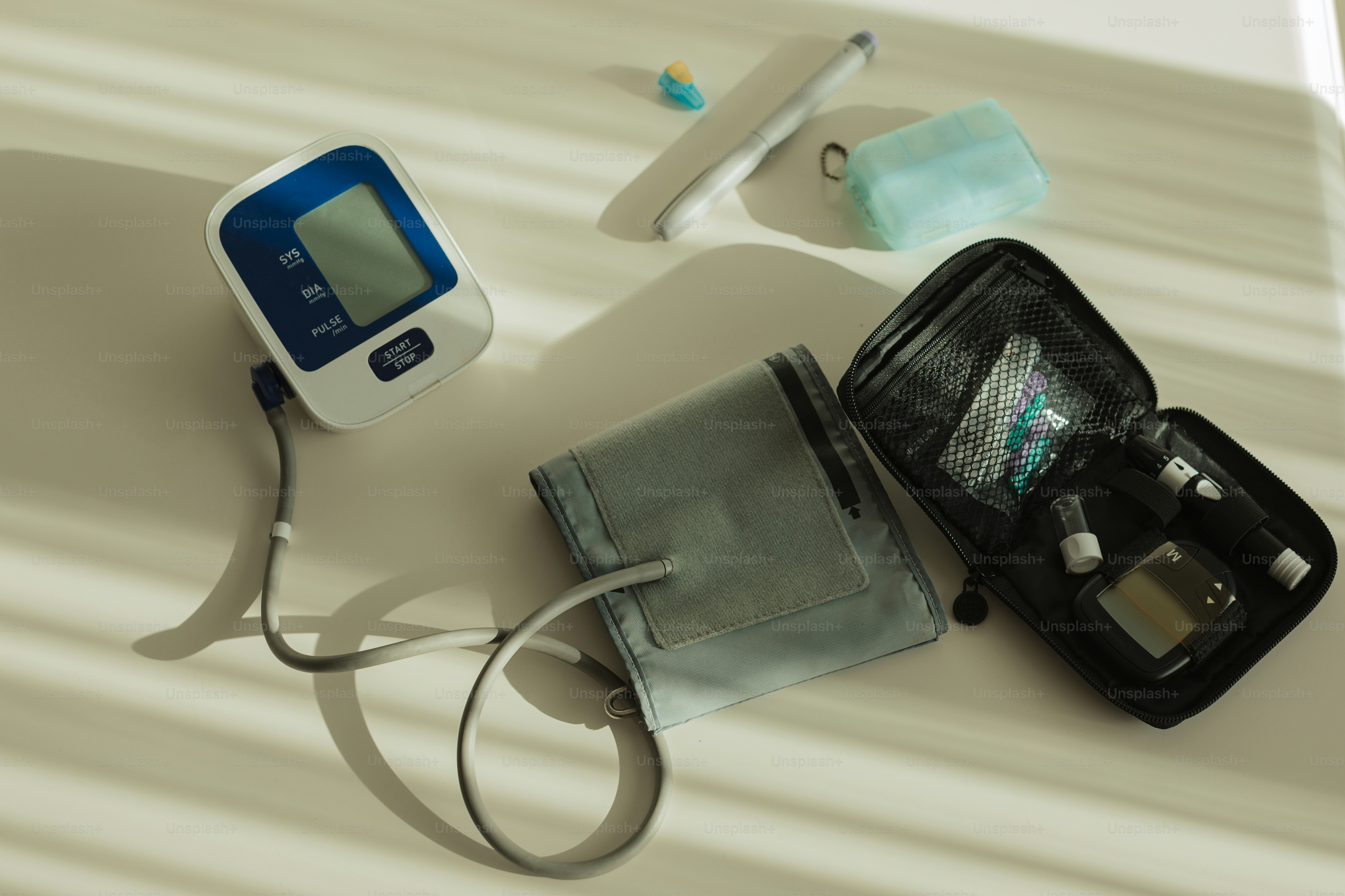 An electronic device and other medical supplies on a table photo ...