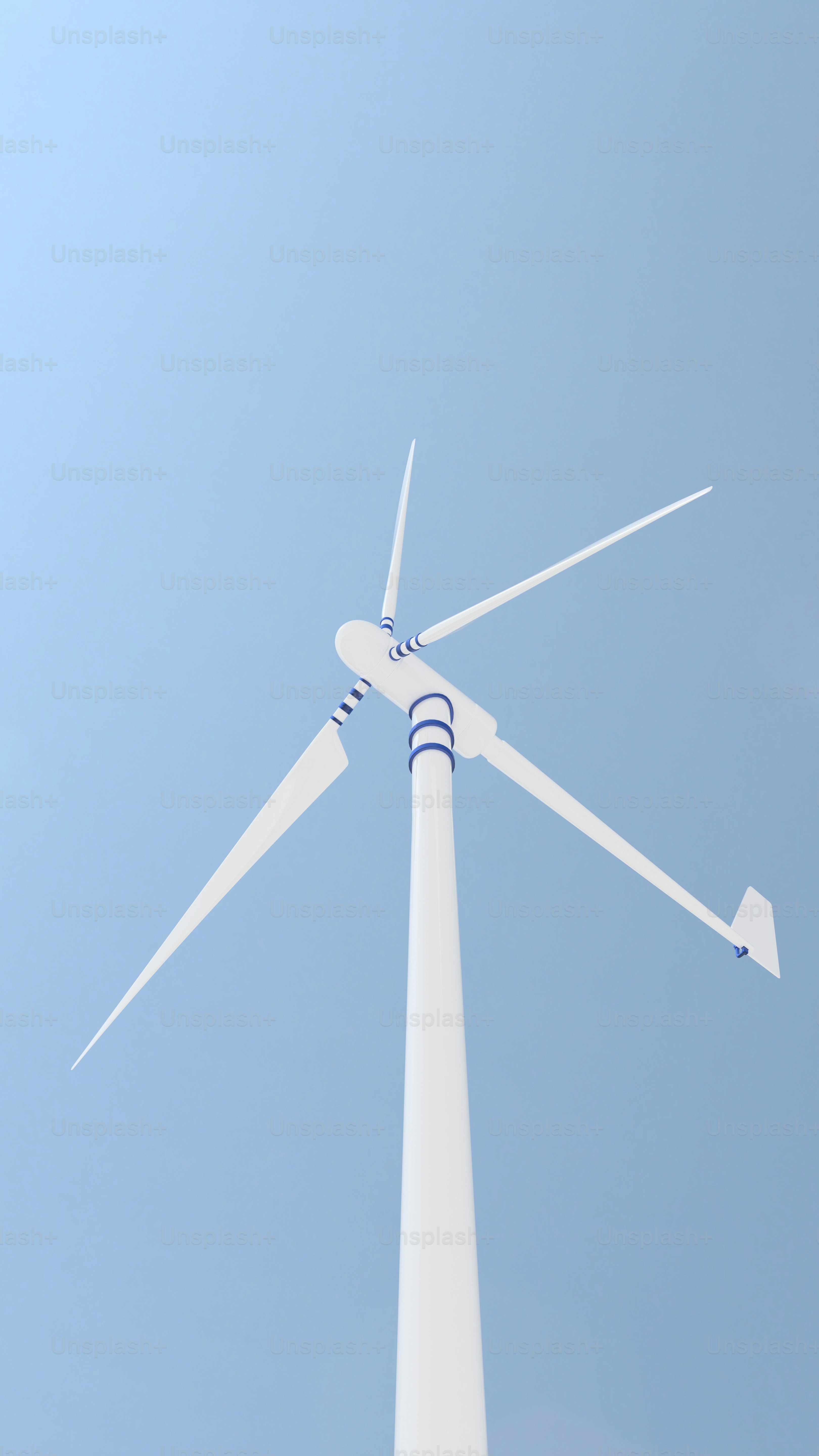 A wind turbine is shown against a blue sky photo – Renewable energy ...