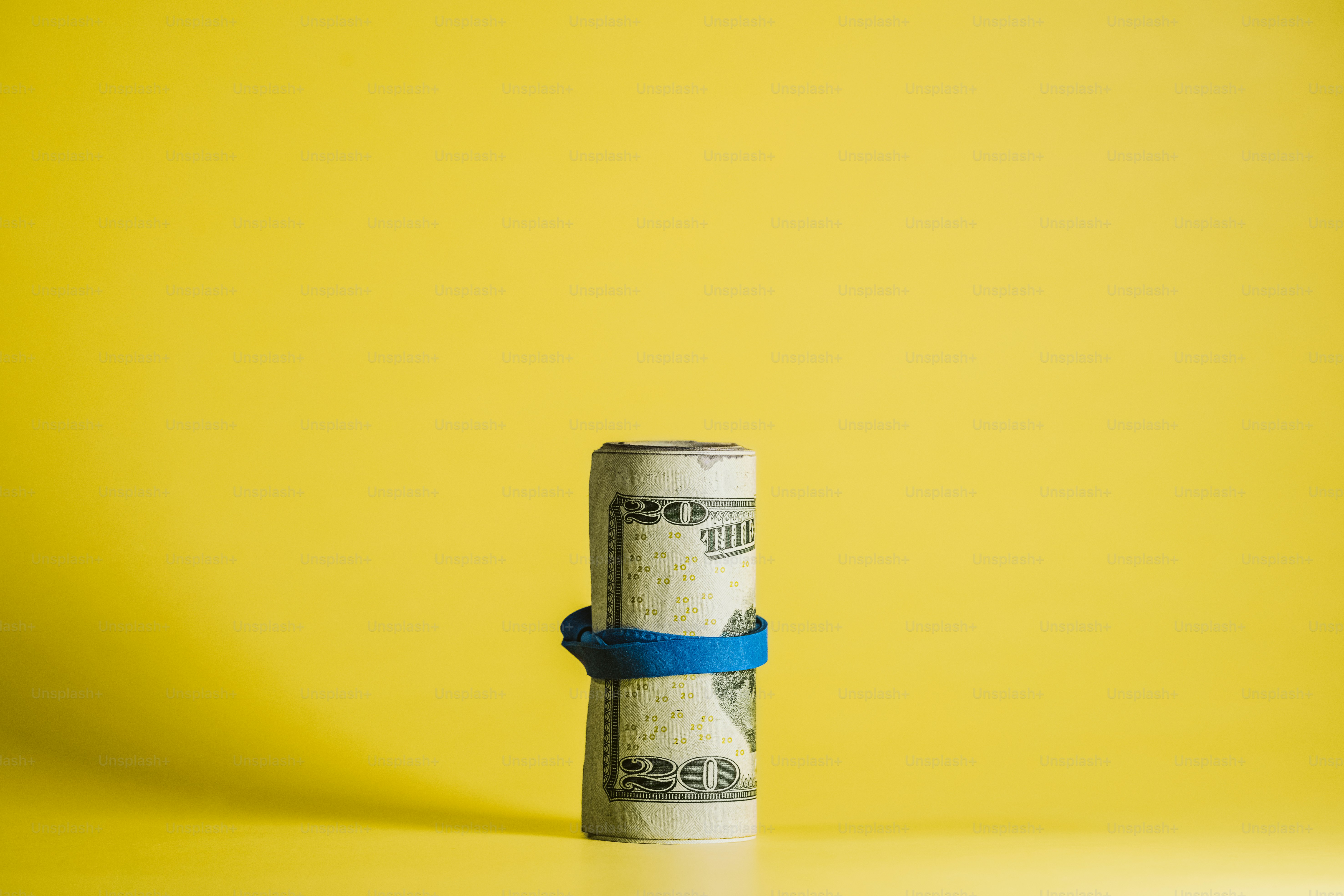 A roll of money wrapped in a blue ribbon photo – Us dollar Image on ...