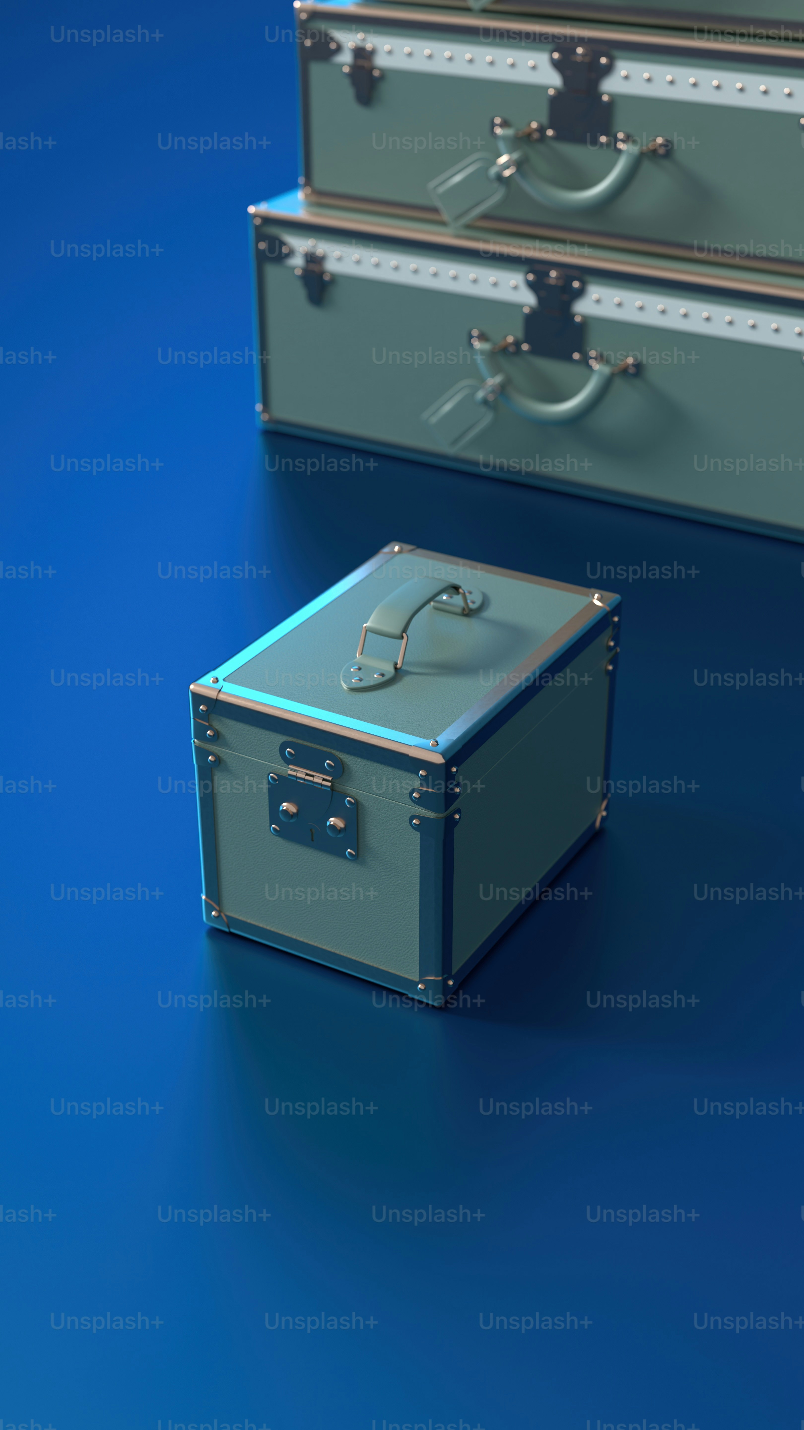 Two suitcases sitting next to each other on a blue surface photo – Full ...