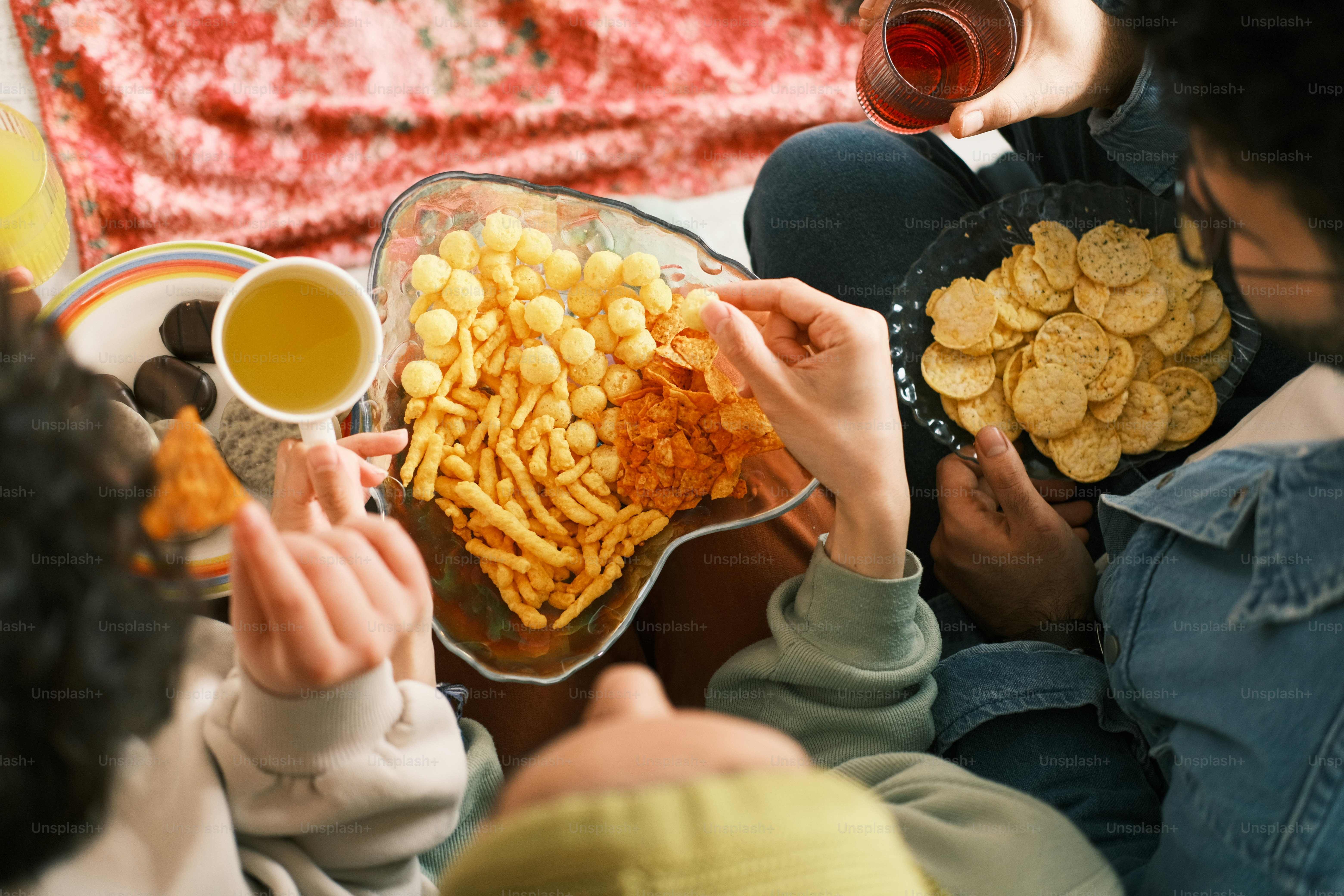 A group of people sitting around a tray of food photo – Food Image on ...