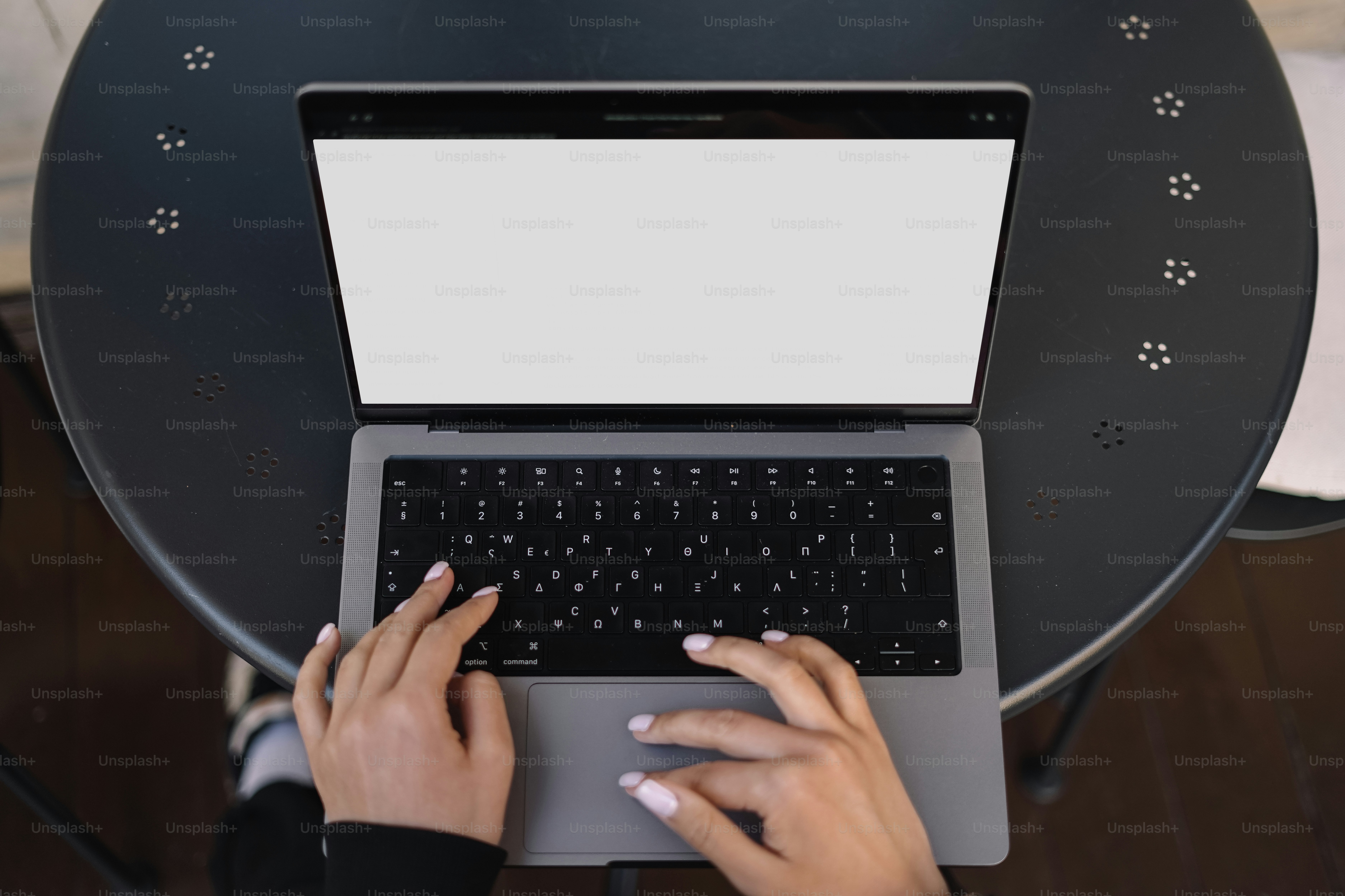 A person typing on a laptop computer on a table photo – Mockup Image on ...