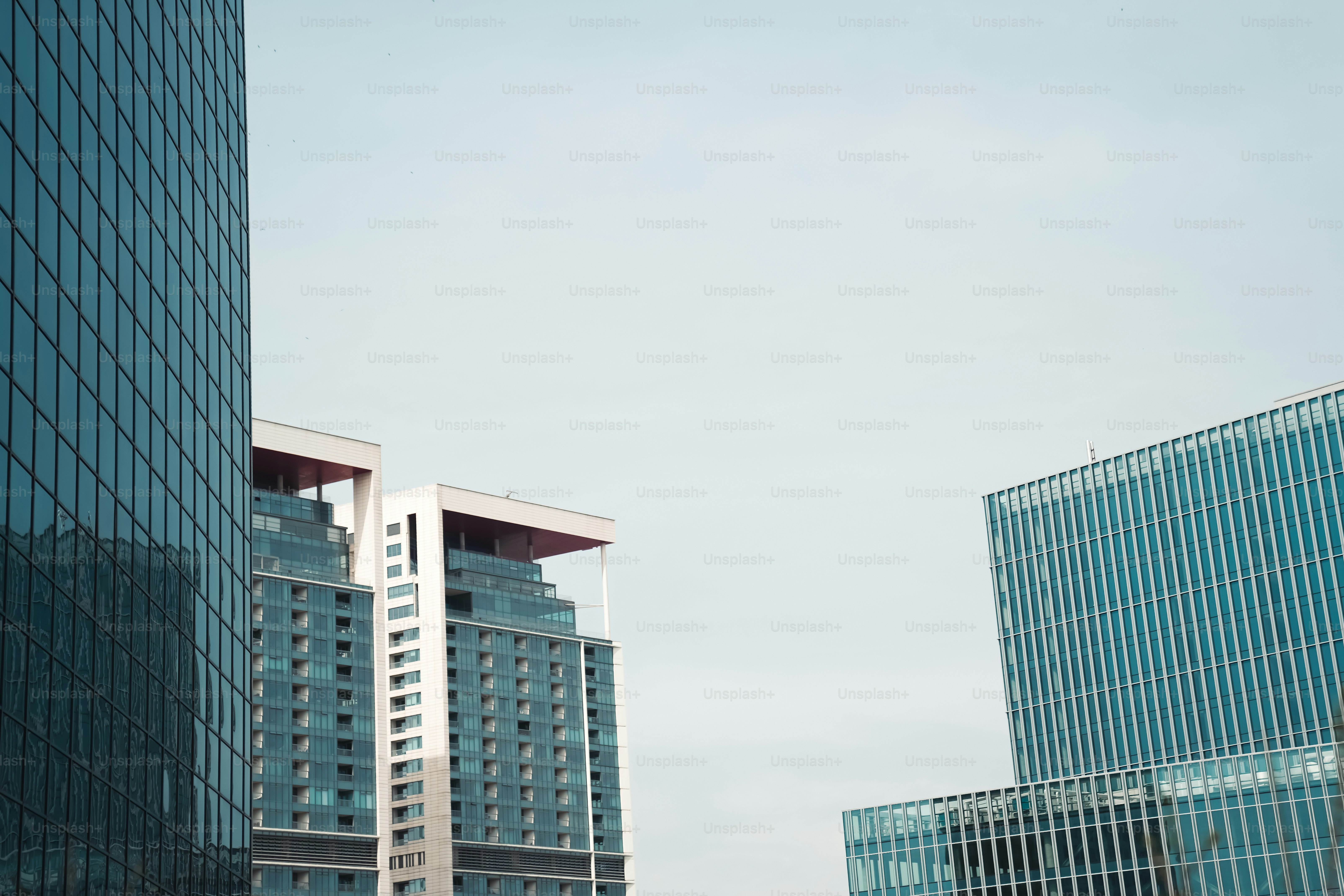 A couple of tall buildings sitting next to each other photo ...