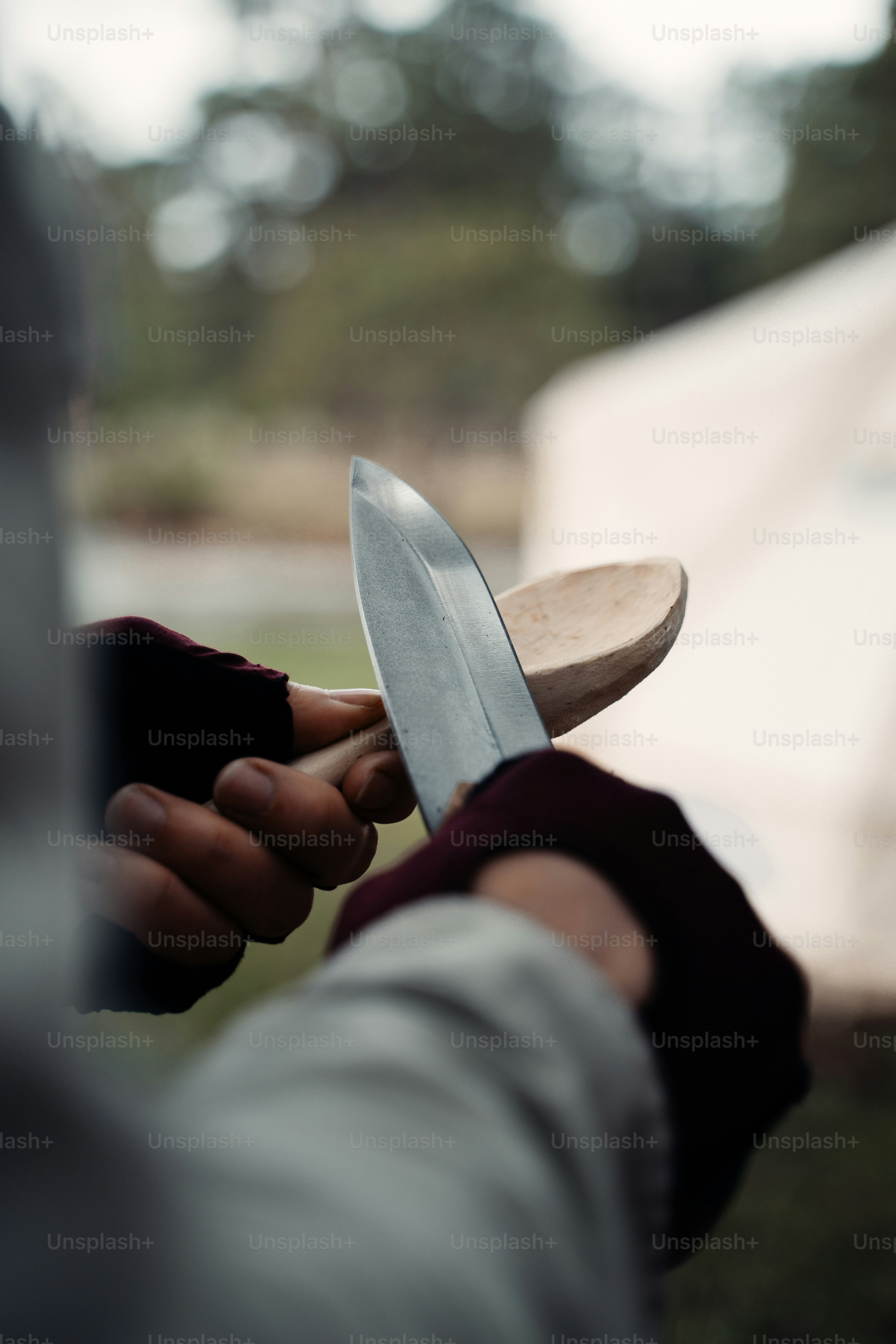A person holding a large knife in their hand photo – Camping Image on ...