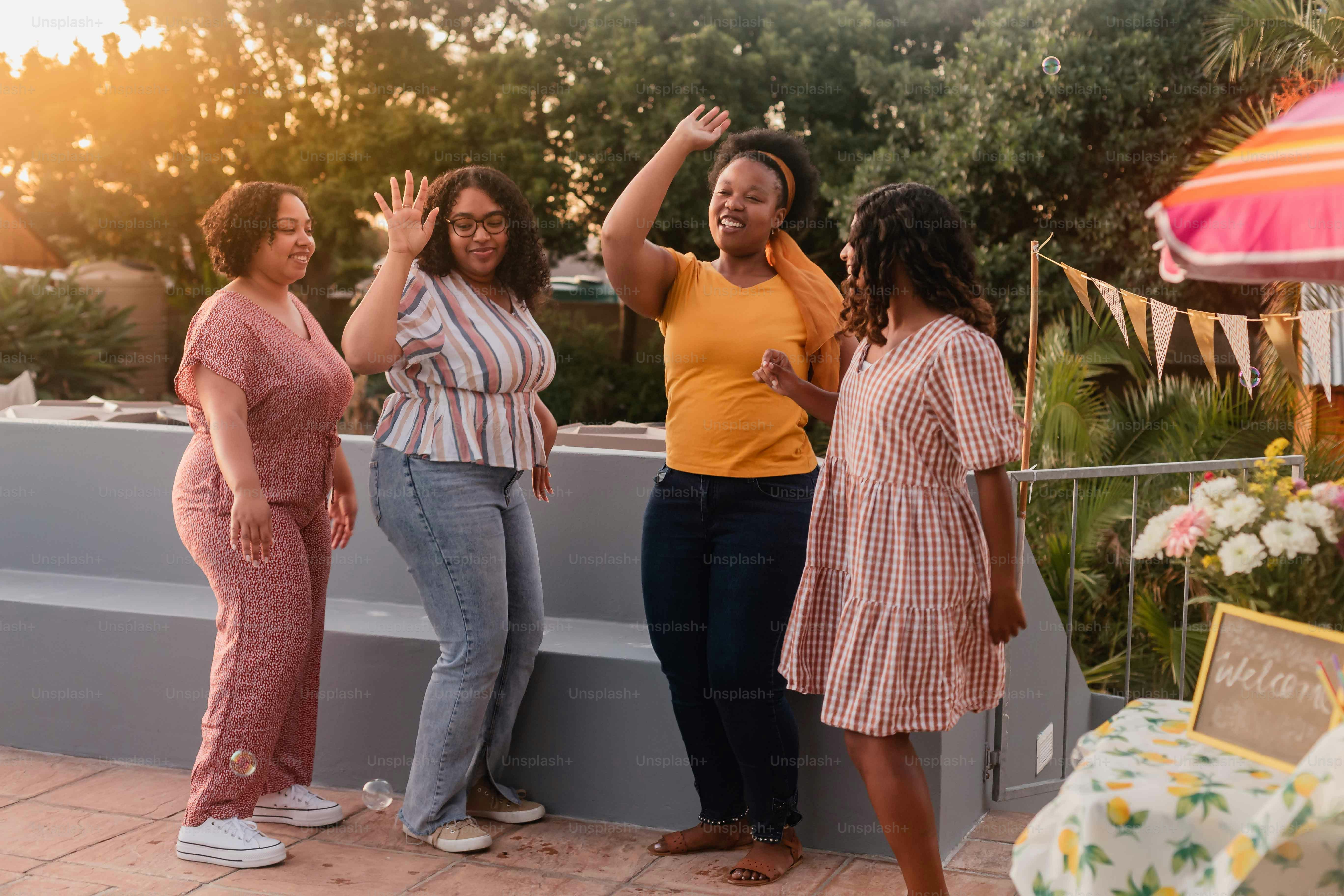 A group of women standing next to each other photo – Summer party Image ...
