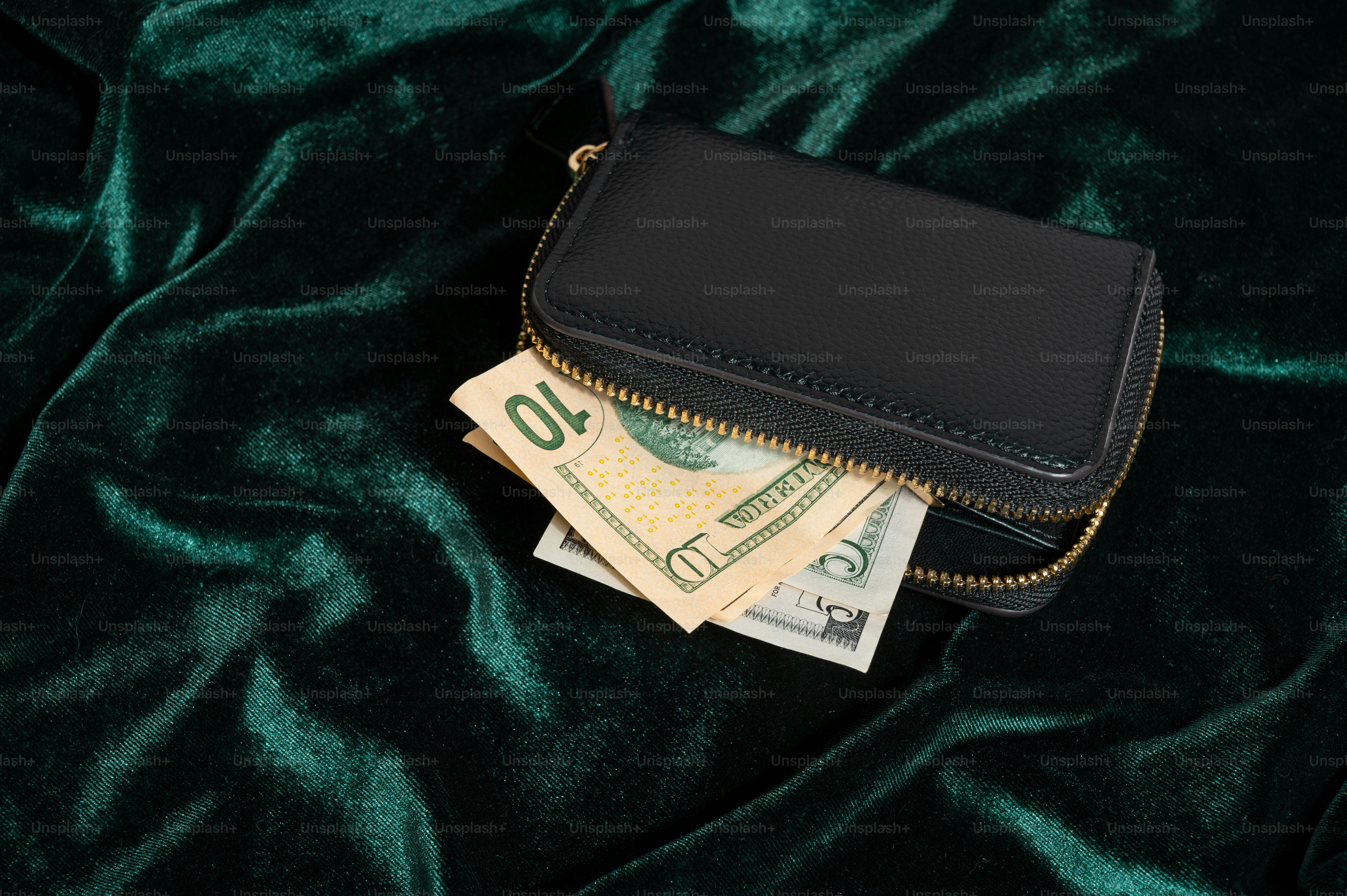 A black purse with money sticking out of it photo – Cash Image on Unsplash