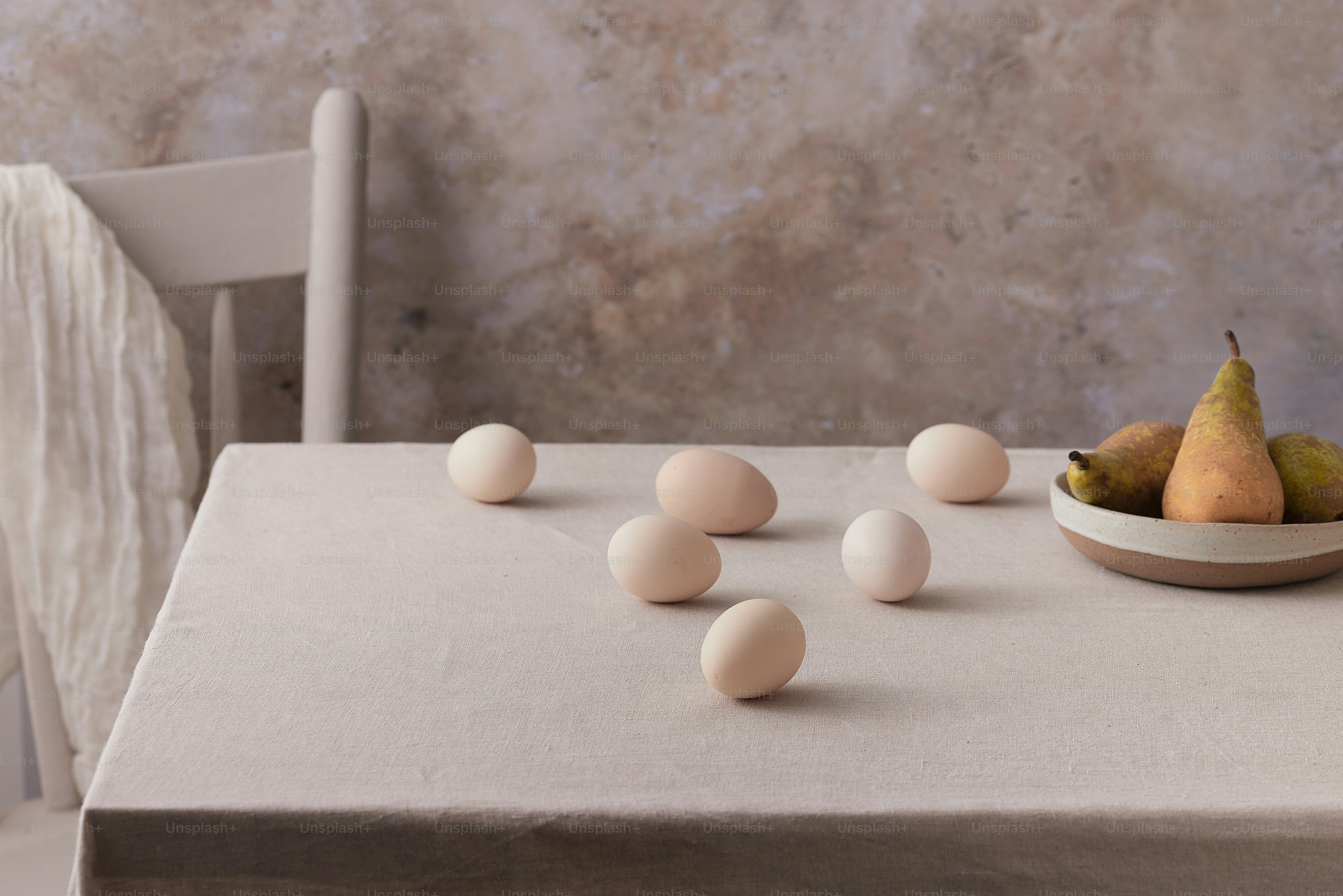A bowl of eggs and some pears on a table photo – Still life Image on ...