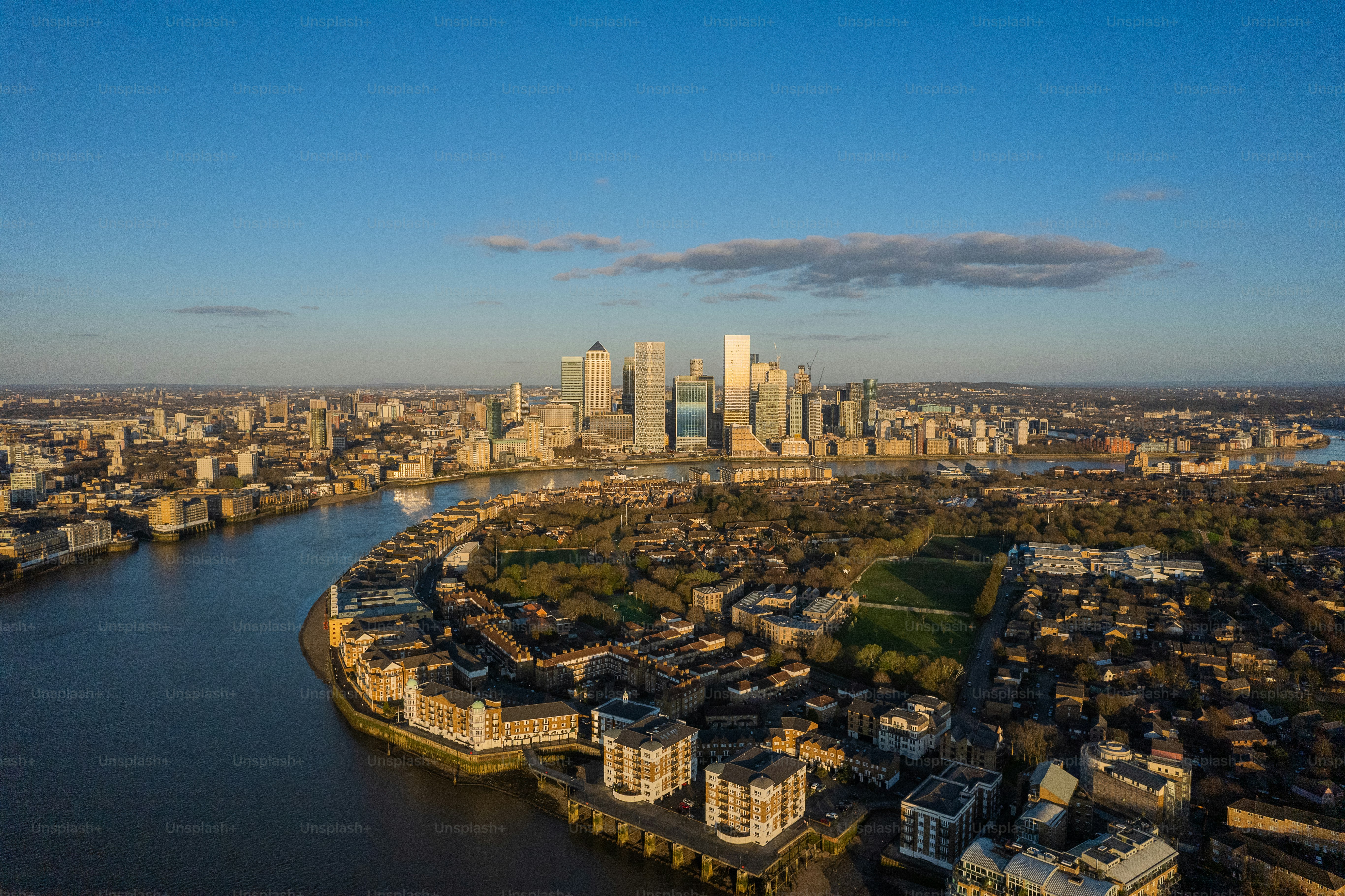 A boat traveling down a river next to a city photo – City Image on Unsplash