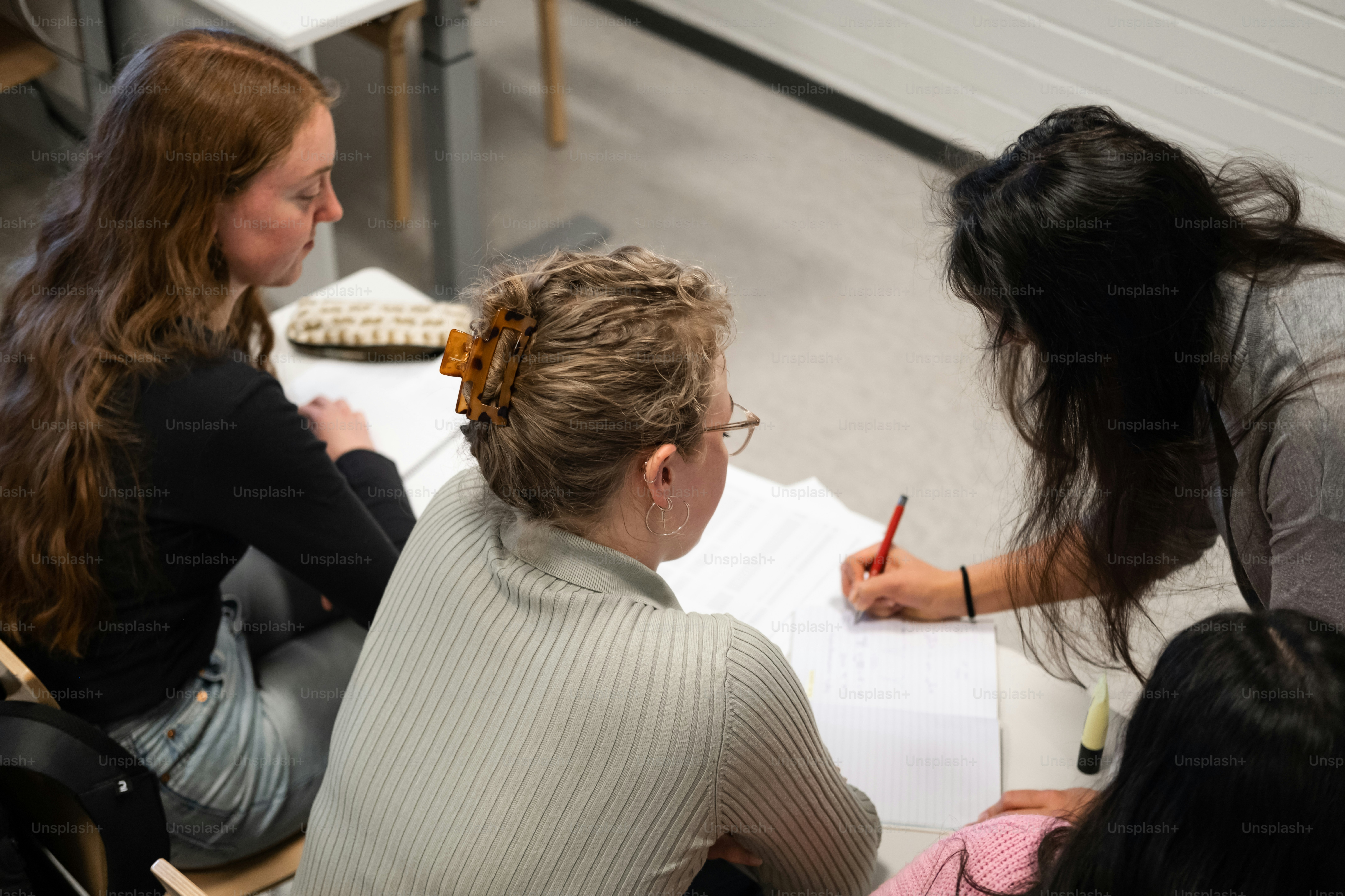 A group of people writing on a white board photo – School Image on Unsplash