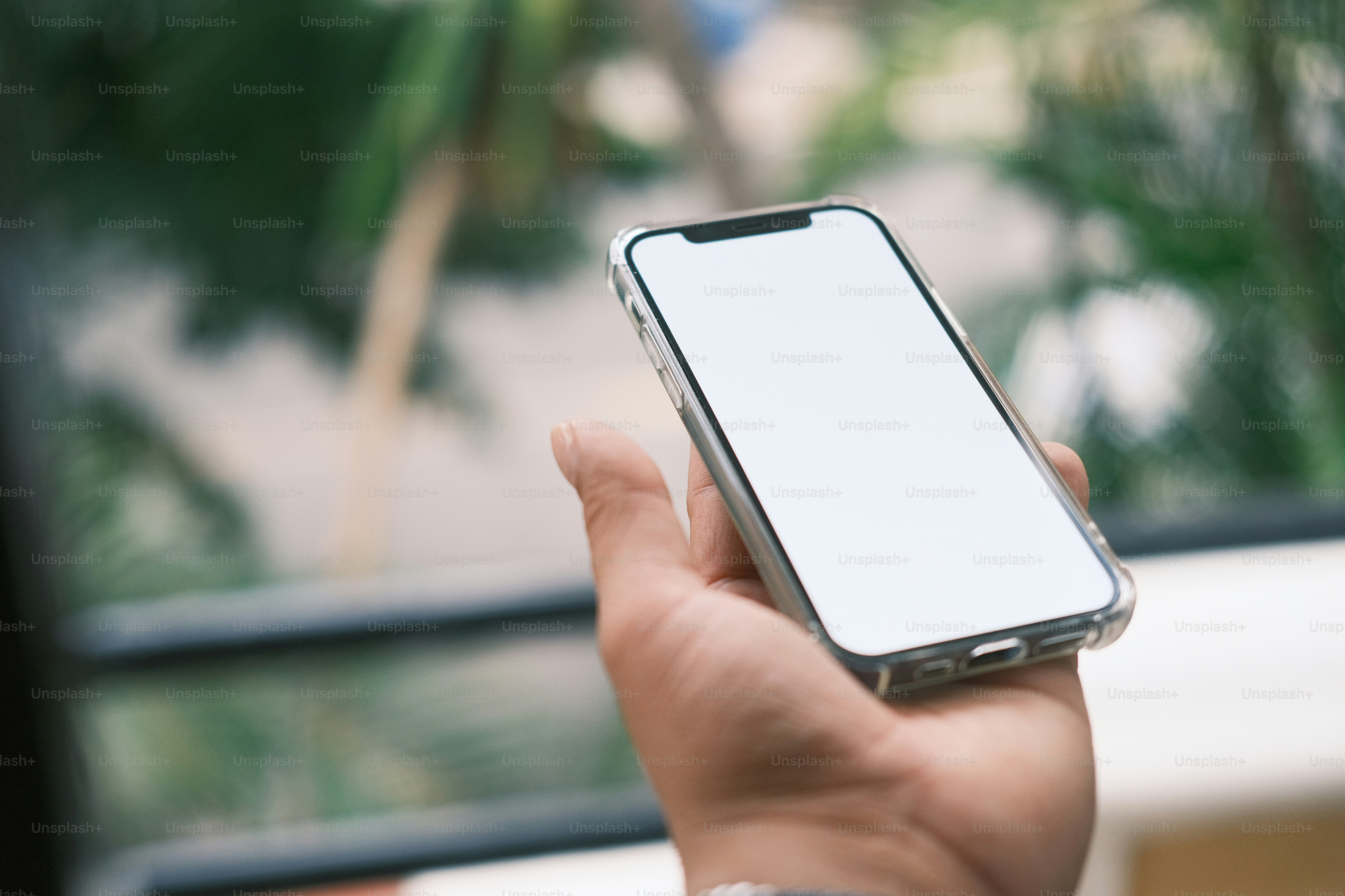 A person holding a cell phone in their hand photo – Product Image on ...